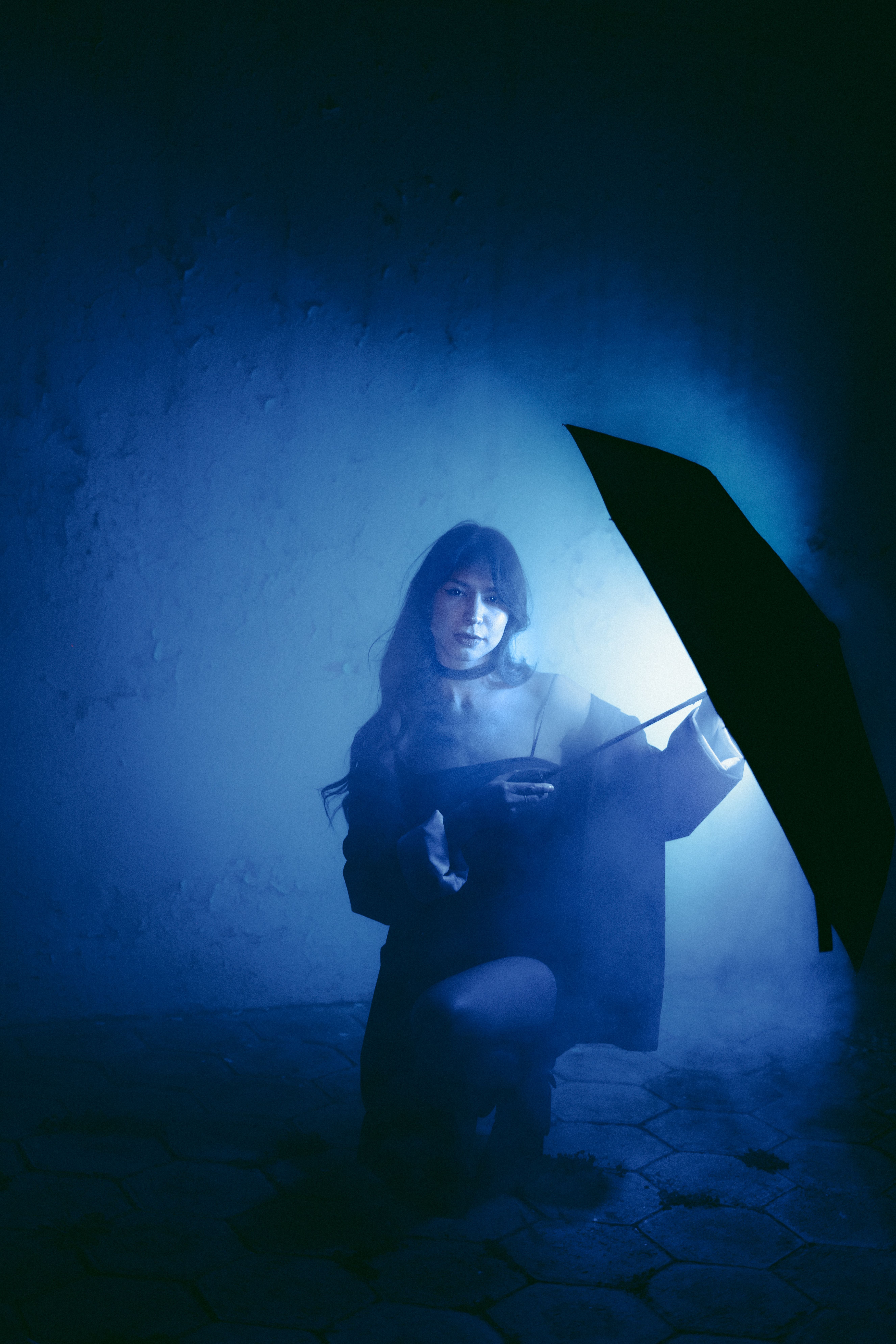 Moody Portrait of Woman with Umbrella in Blue Fog · Free Stock Photo