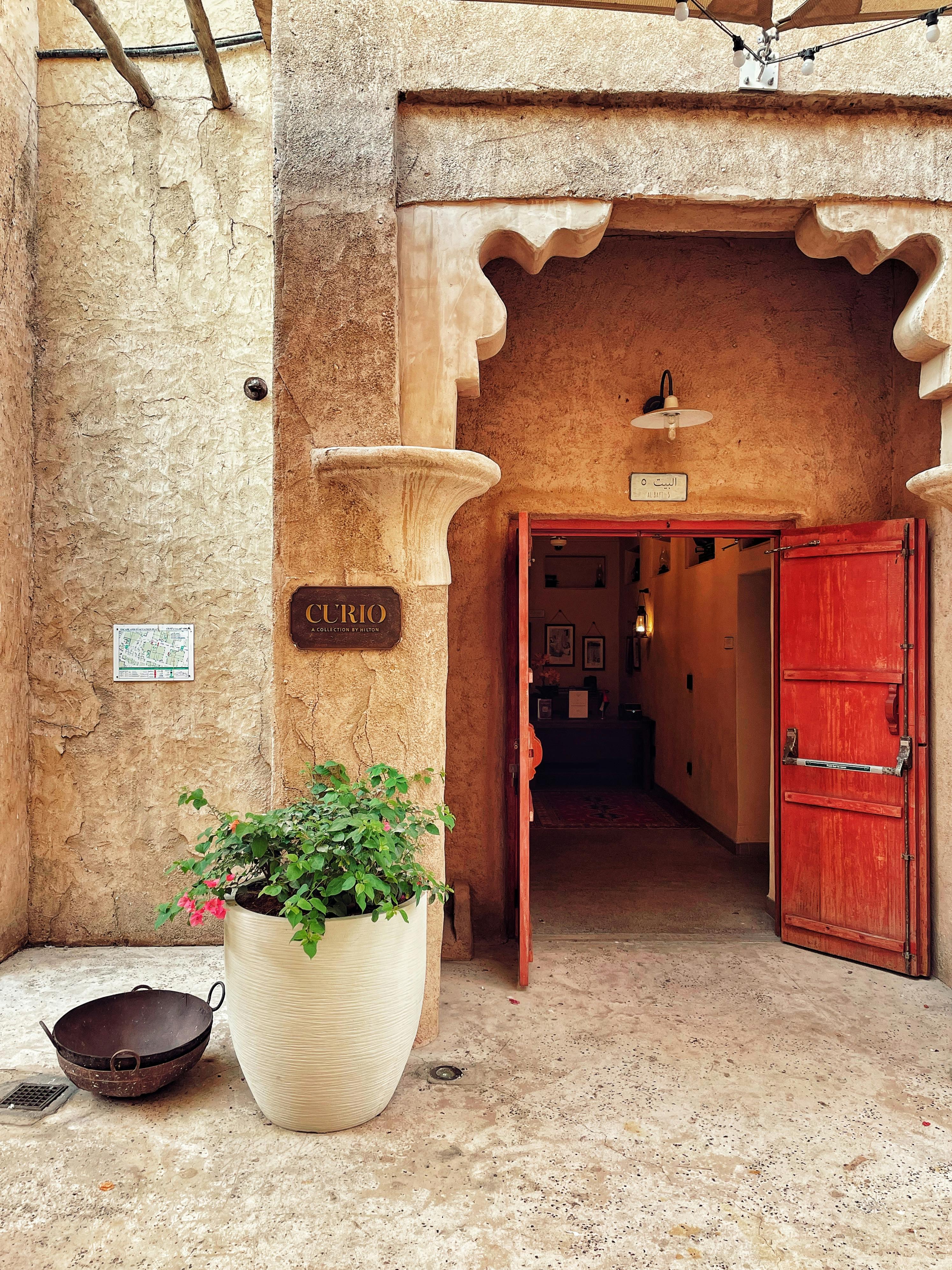 Rustic Middle Eastern Courtyard Entrance with Red Doors · Free Stock Photo