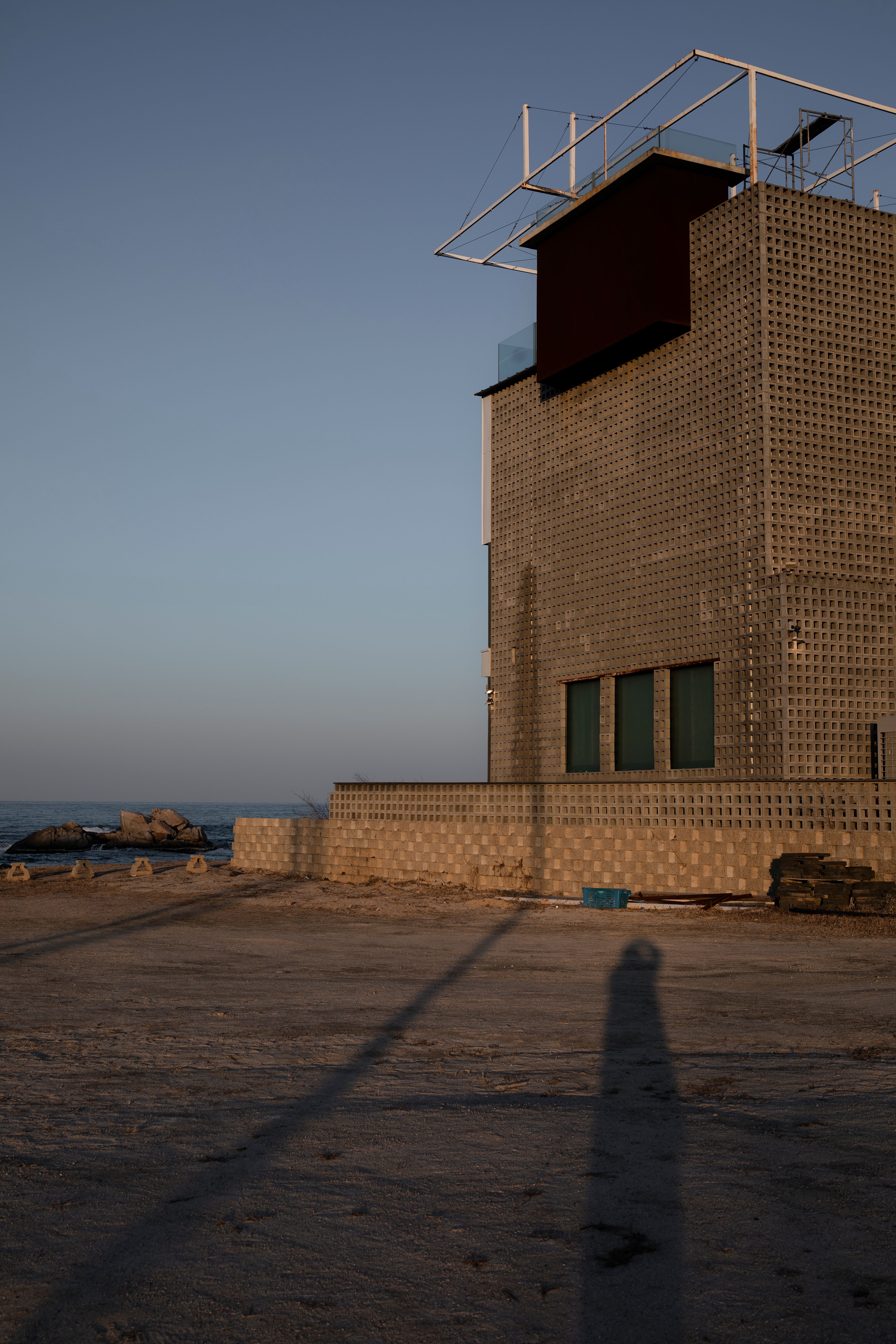 Modern Coastal Building with Shadow at Sunset · Free Stock Photo