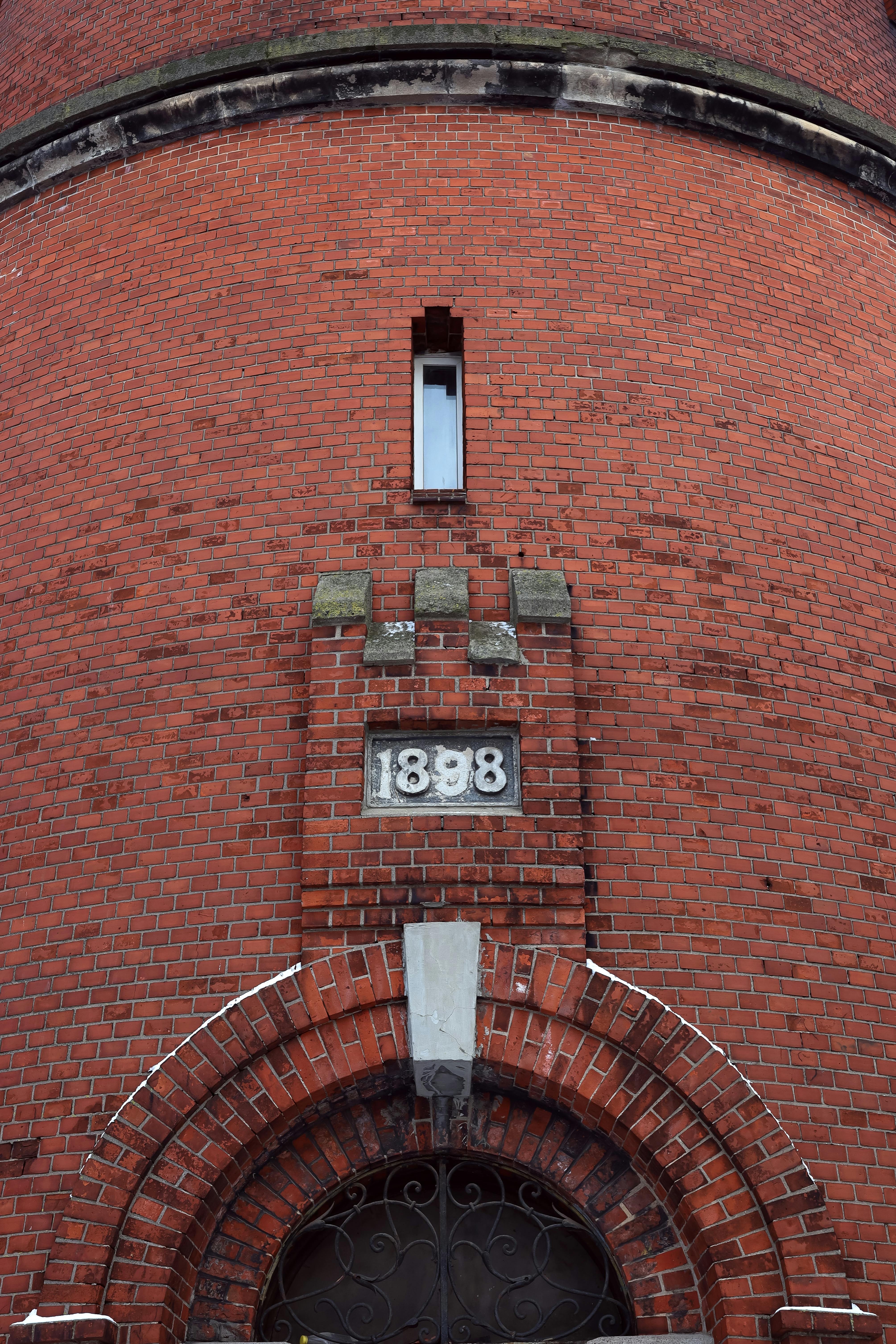 Brick Tower Facade with 1898 Inscription · Free Stock Photo