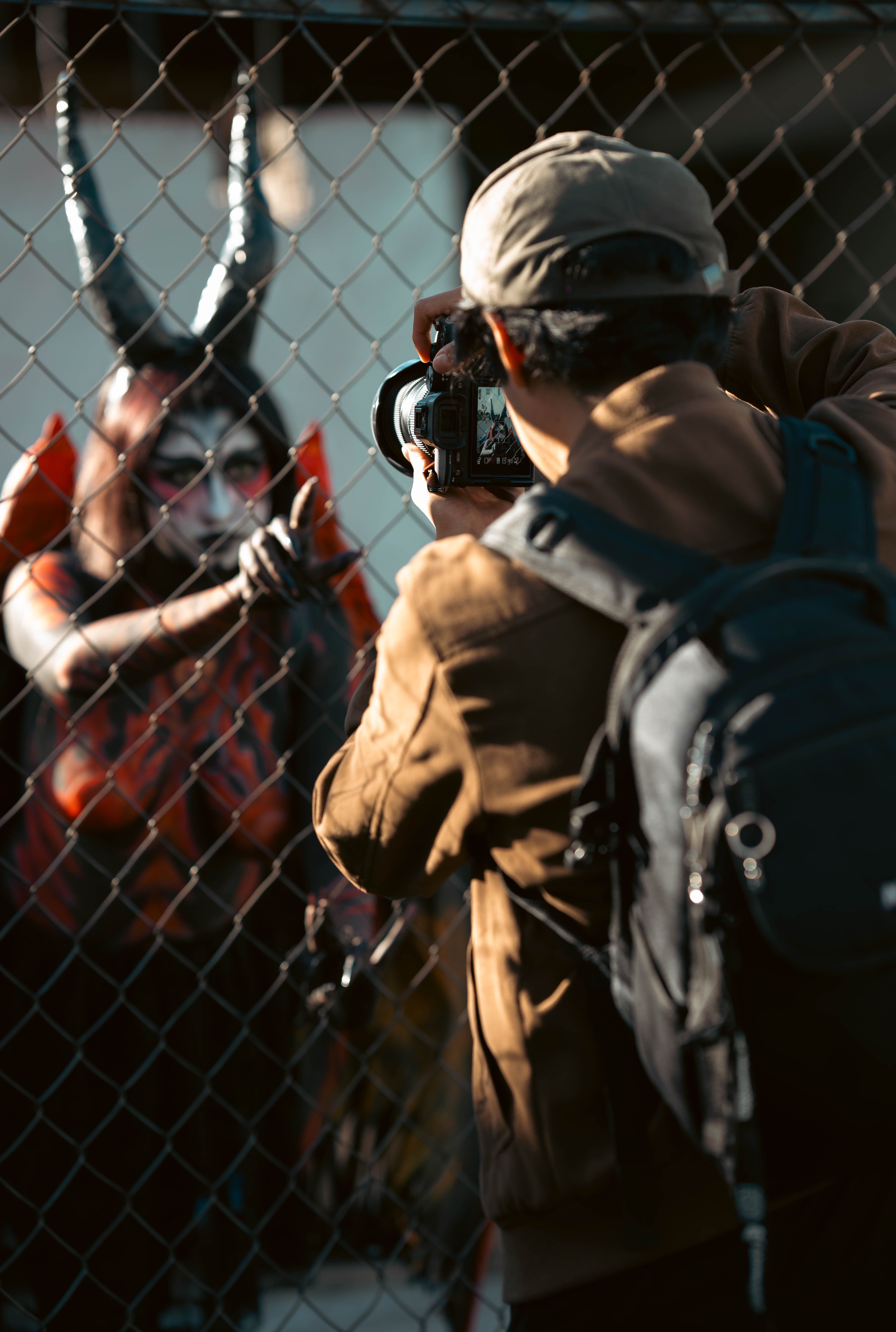 Street Photographer Captures Clown Behind Fence · Free Stock Photo