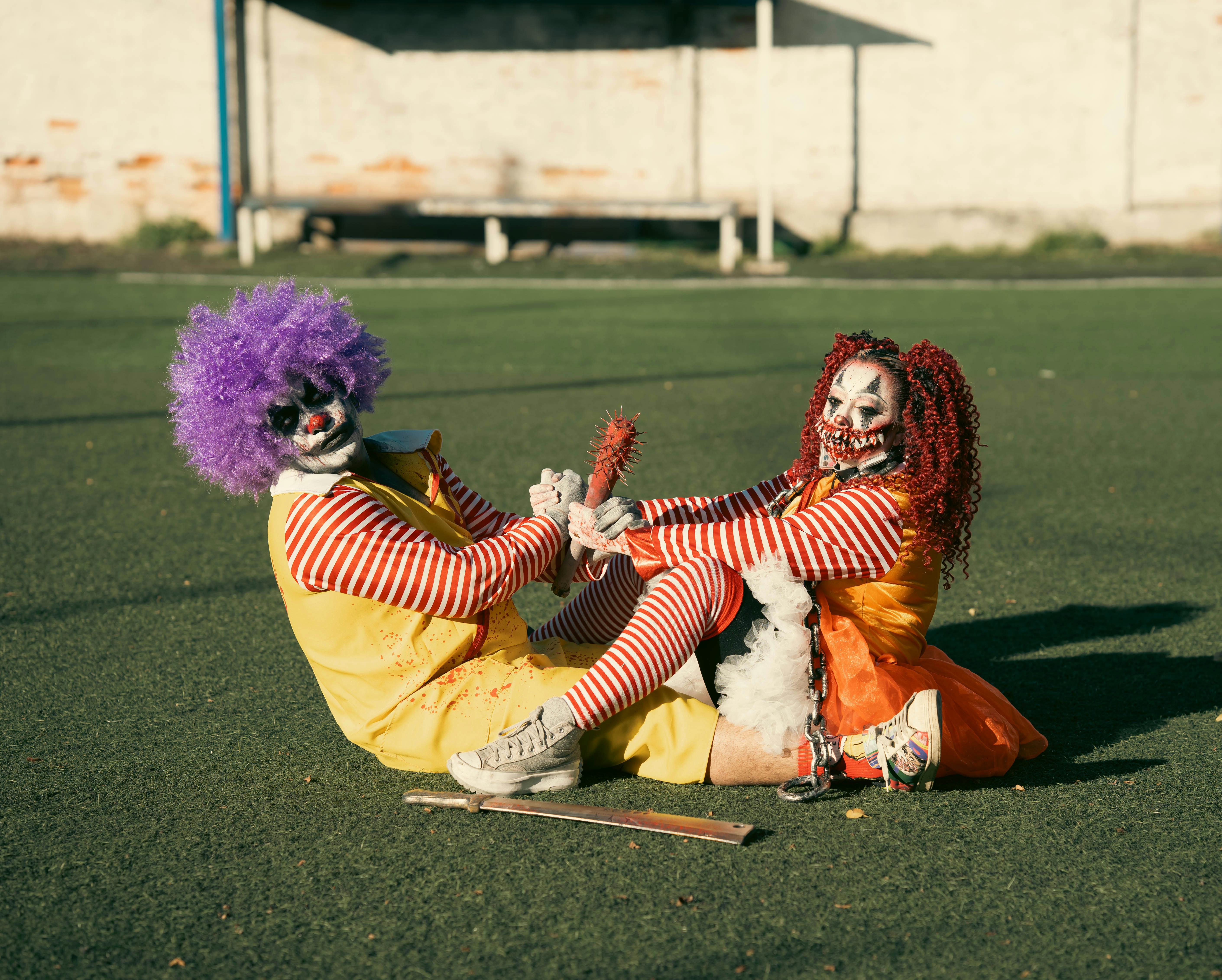 Clowns Playing Outdoors in Colorful Costumes · Free Stock Photo