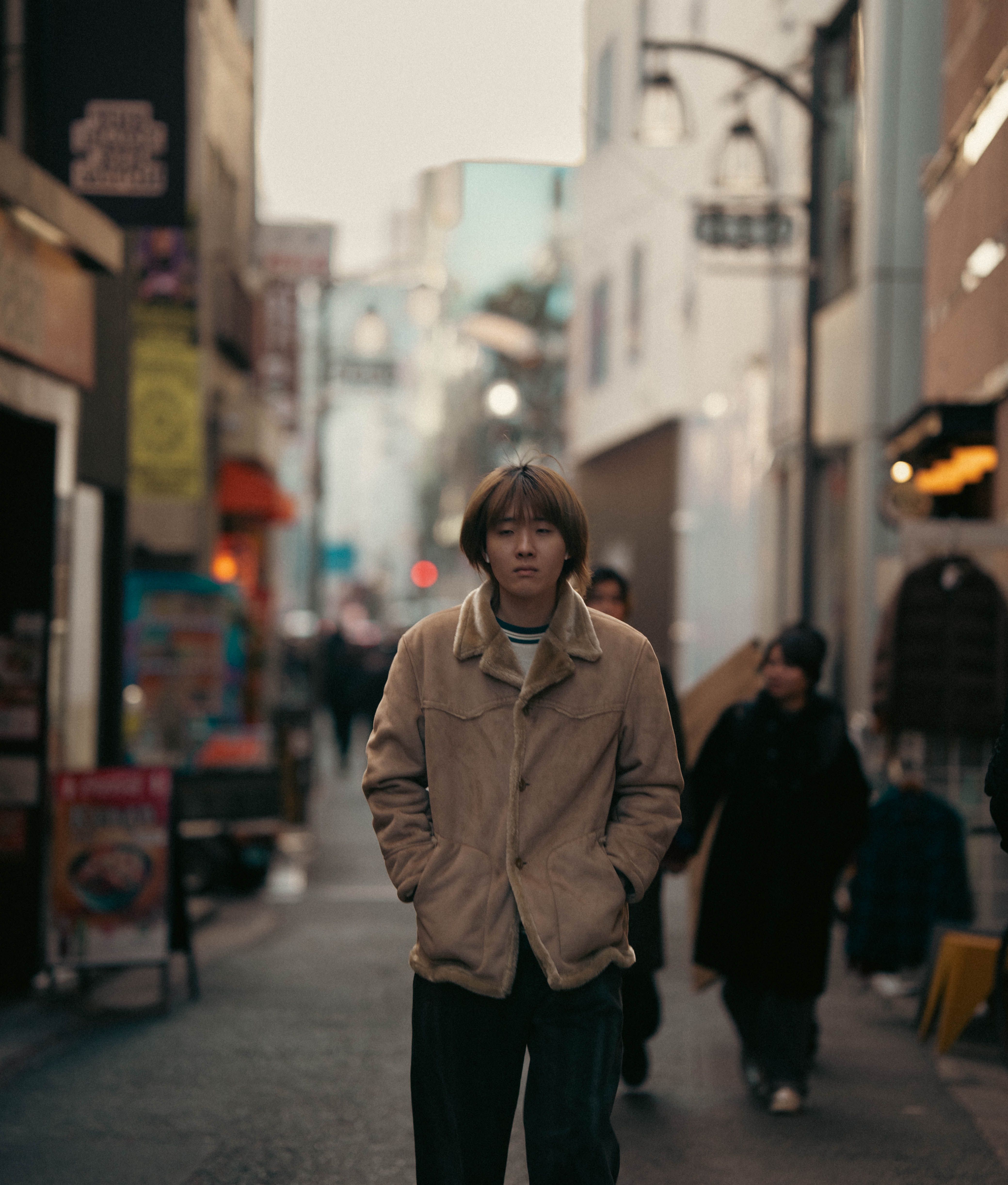 Young adult walking in urban Japanese street · Free Stock Photo