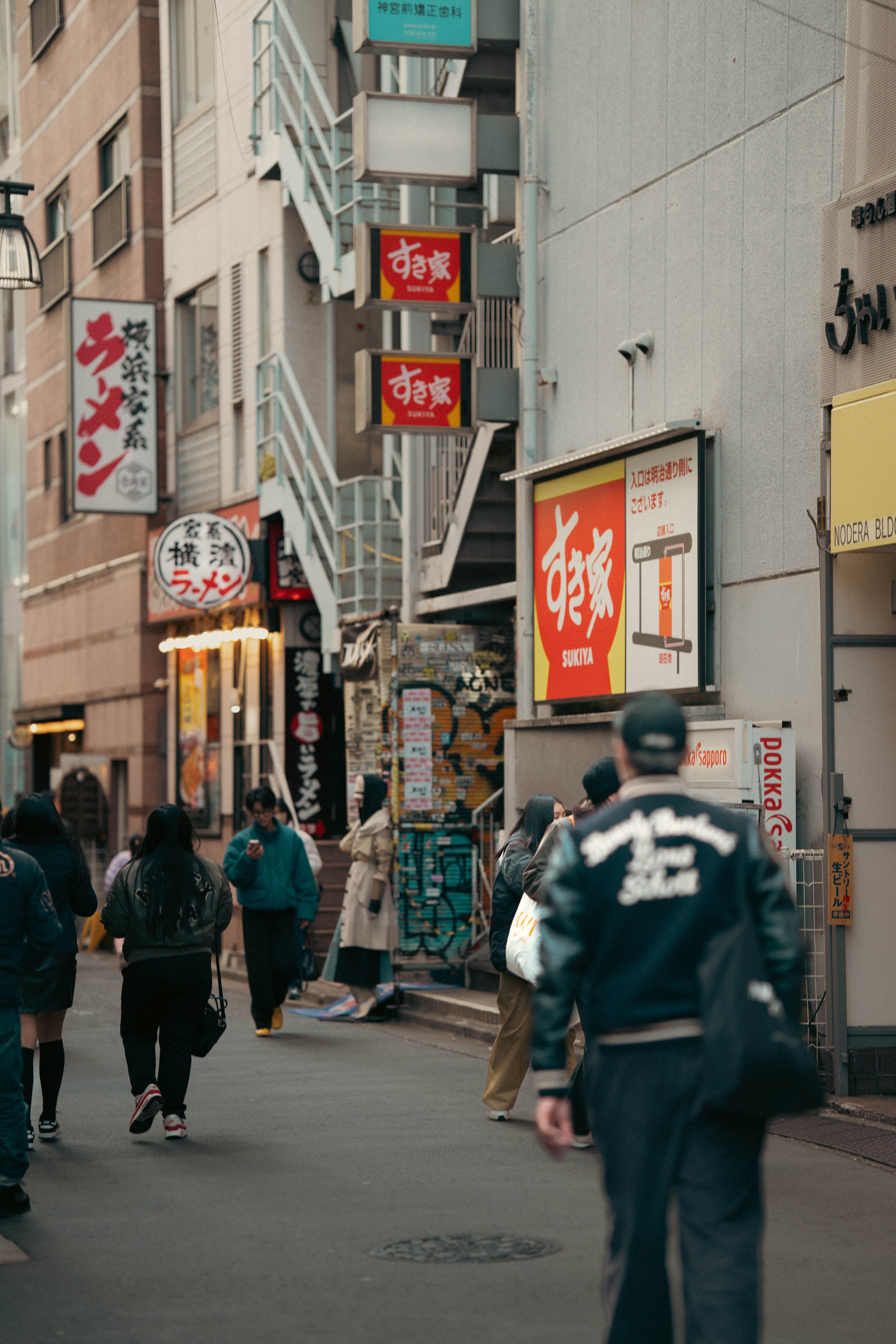 Bustling Urban Street in Japan with Shops and Pedestrians · Free Stock ...