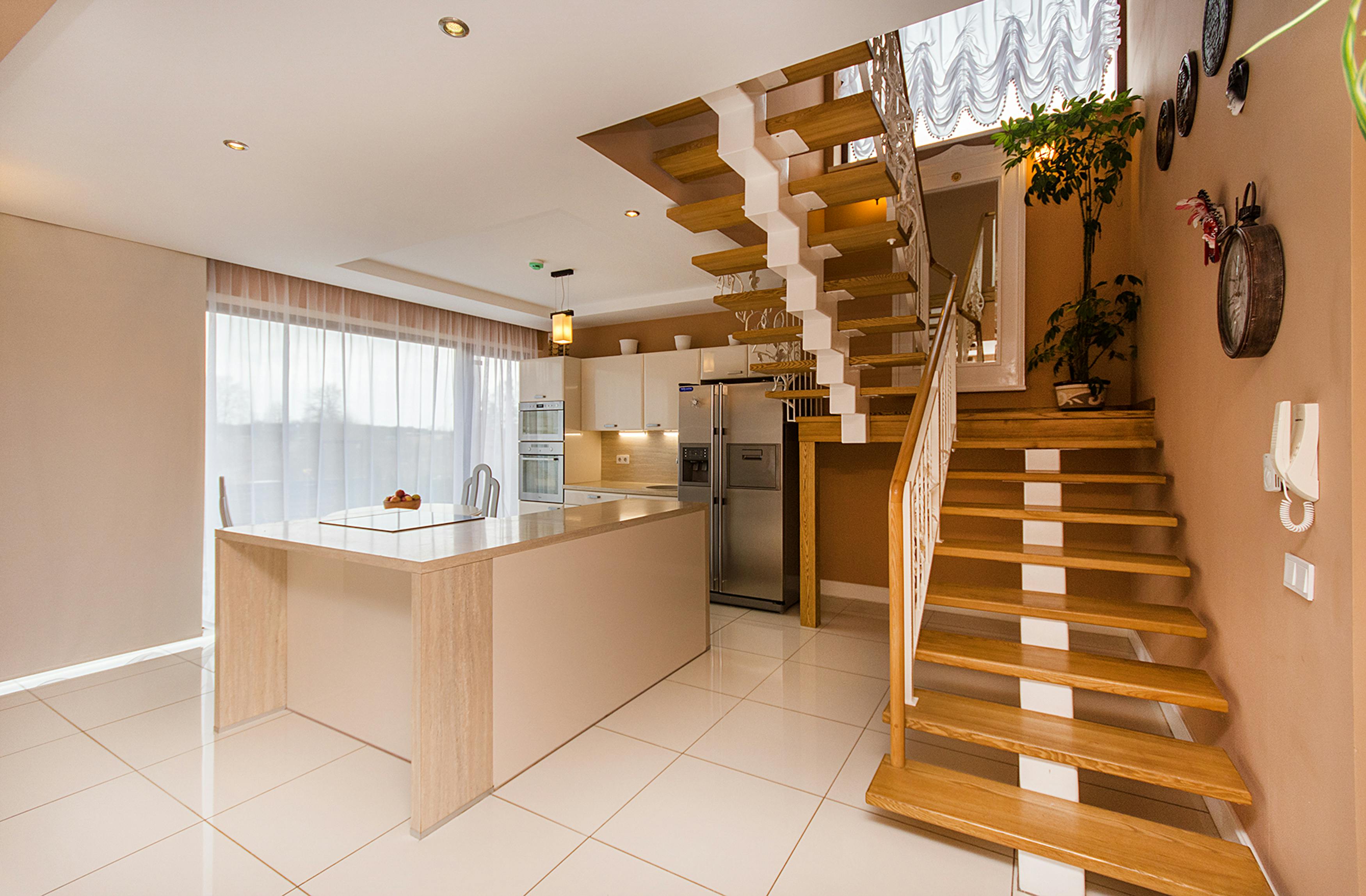 Modern Kitchen Interior with Wooden Staircase · Free Stock Photo