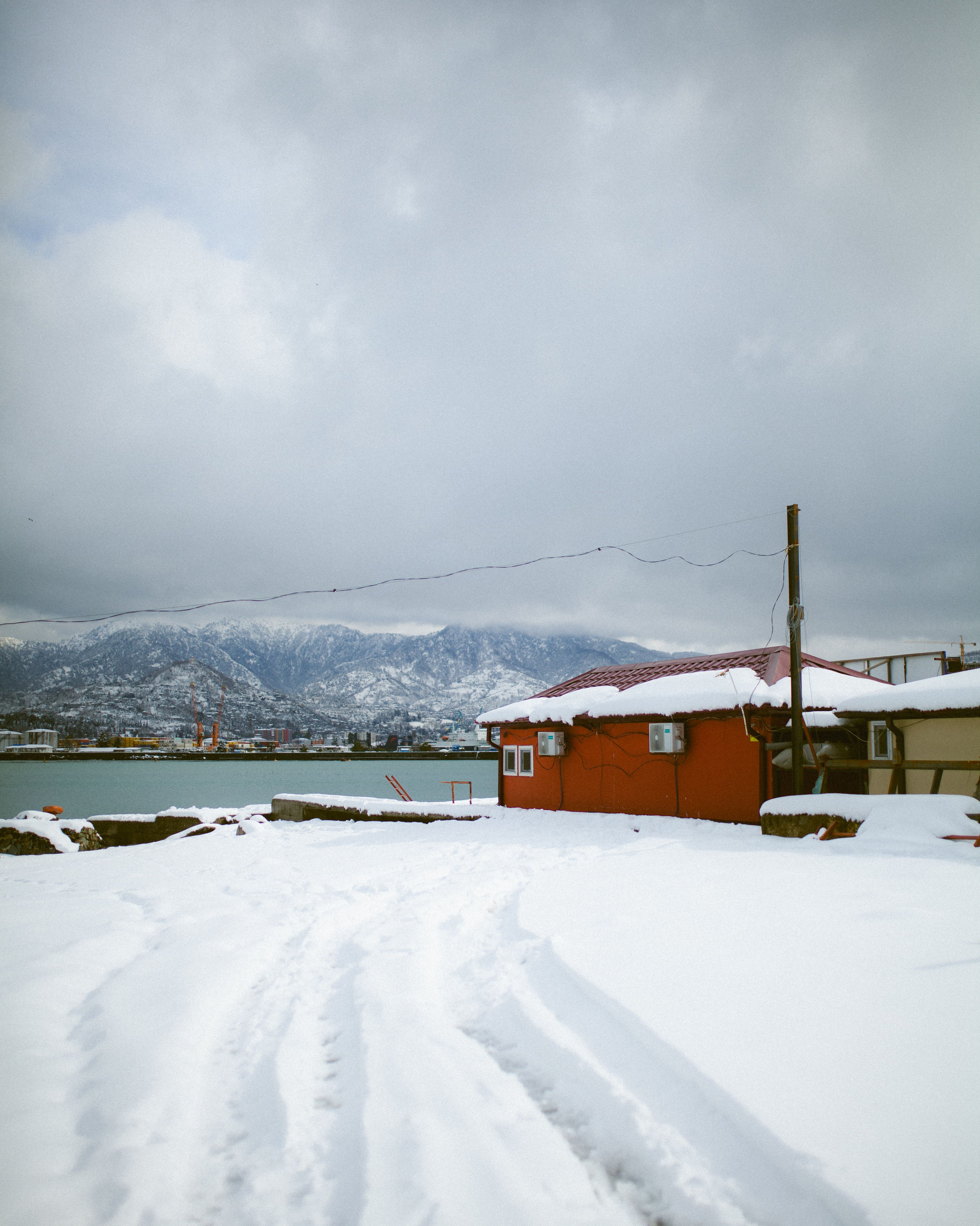 Snowy Landscape with Vibrant Red Building in Winter · Free Stock Photo