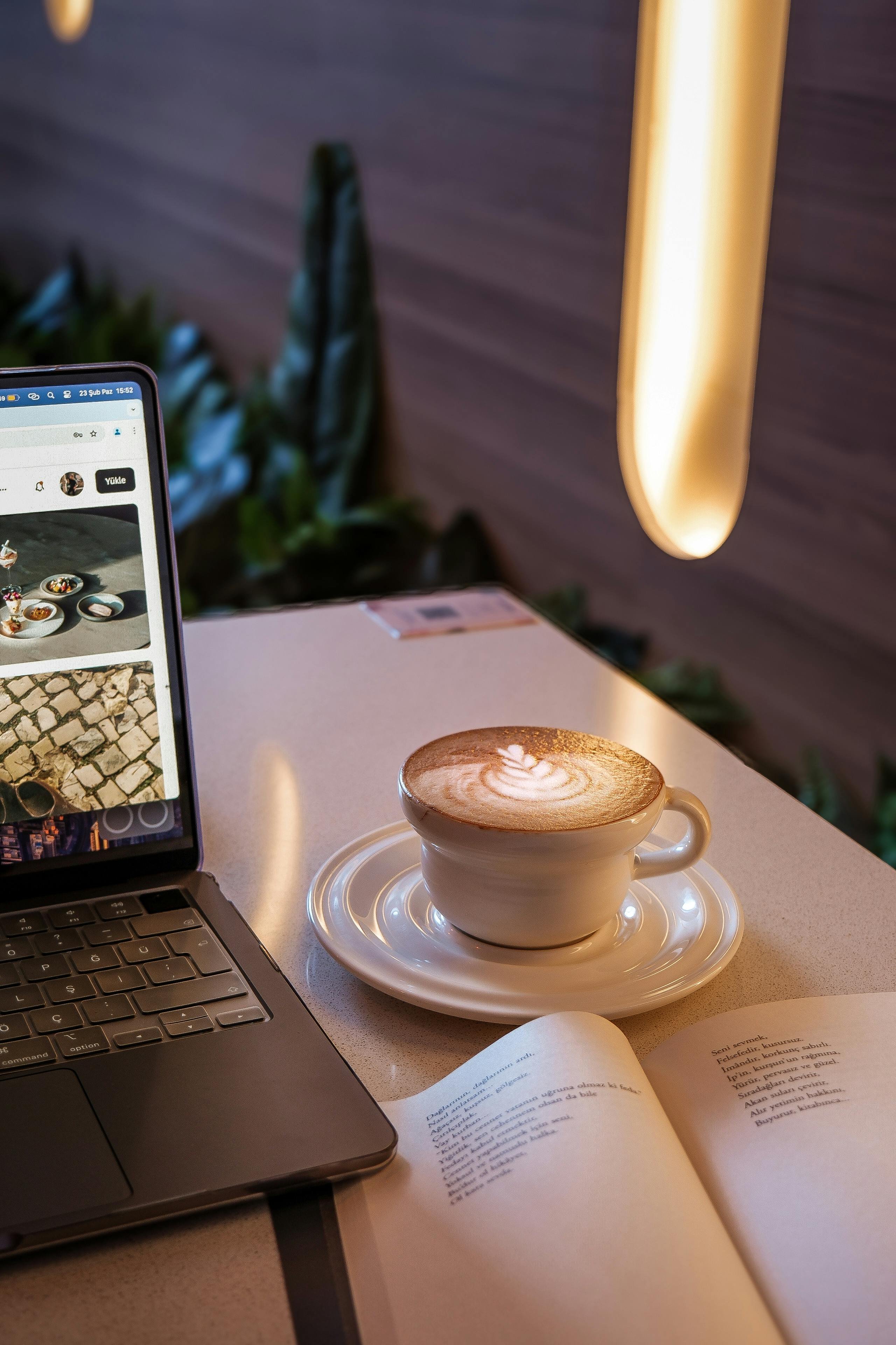 Cozy Coffee Shop Workspace with Laptop · Free Stock Photo