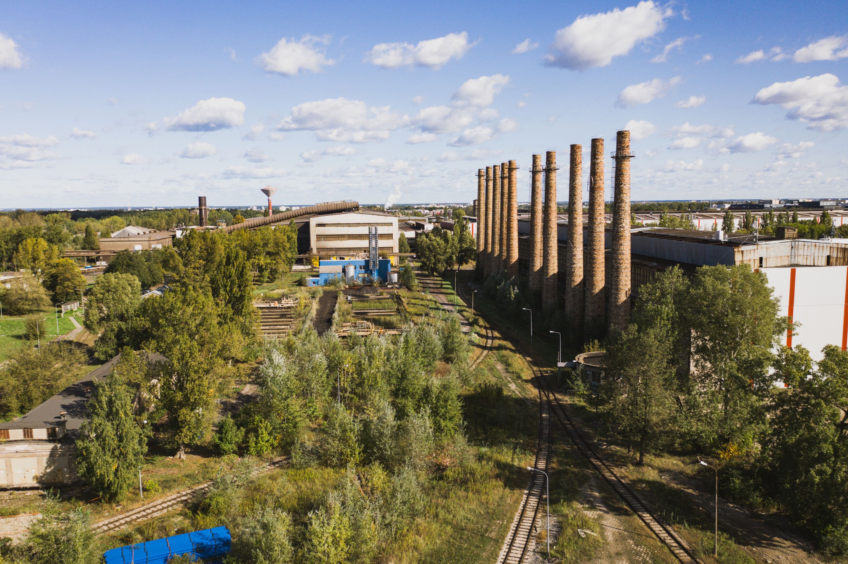 Aerial View of Industrial Facility with Tall Chimneys · Free Stock Photo