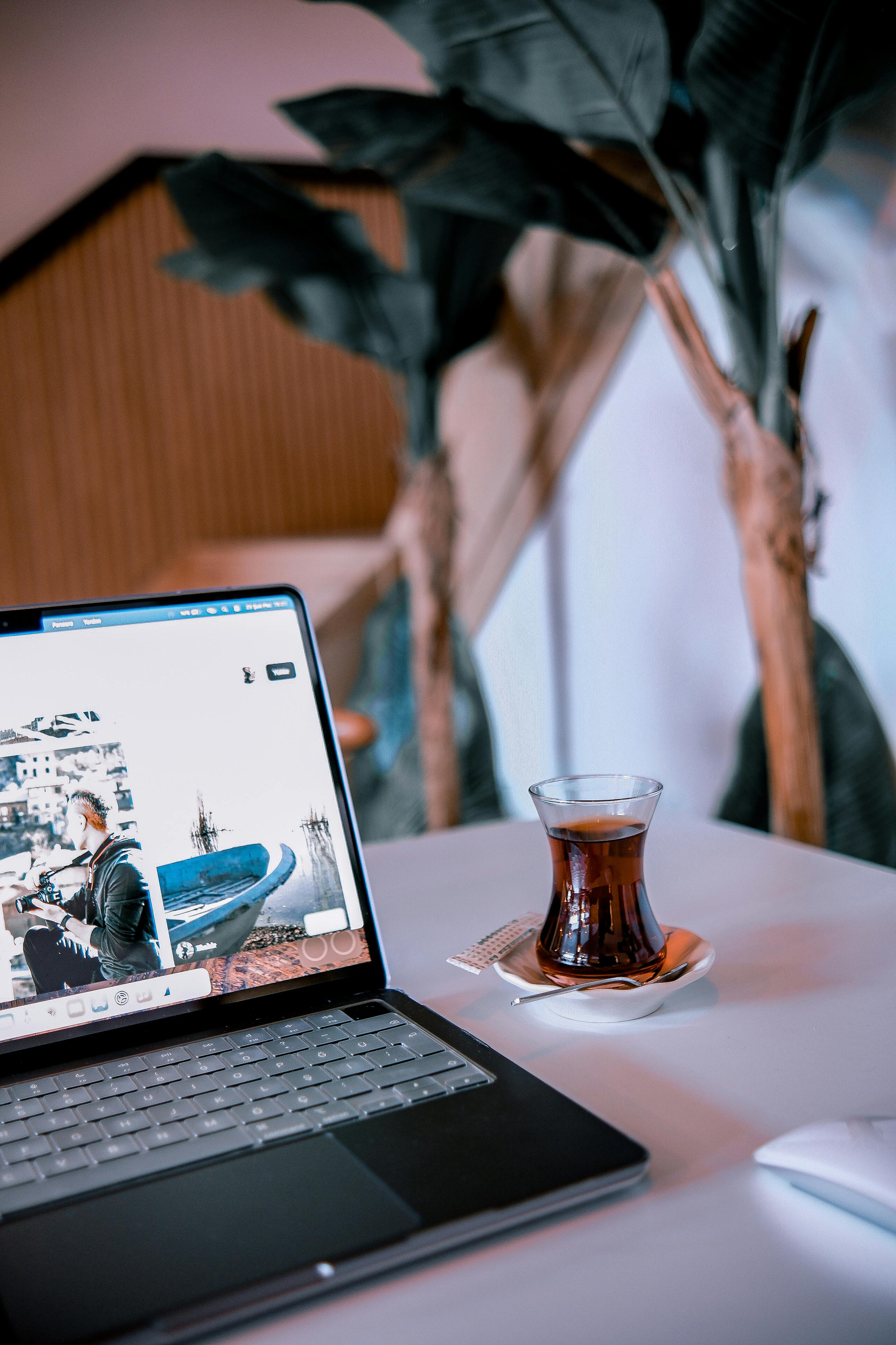 Modern Office Desk with Laptop and Turkish Tea · Free Stock Photo