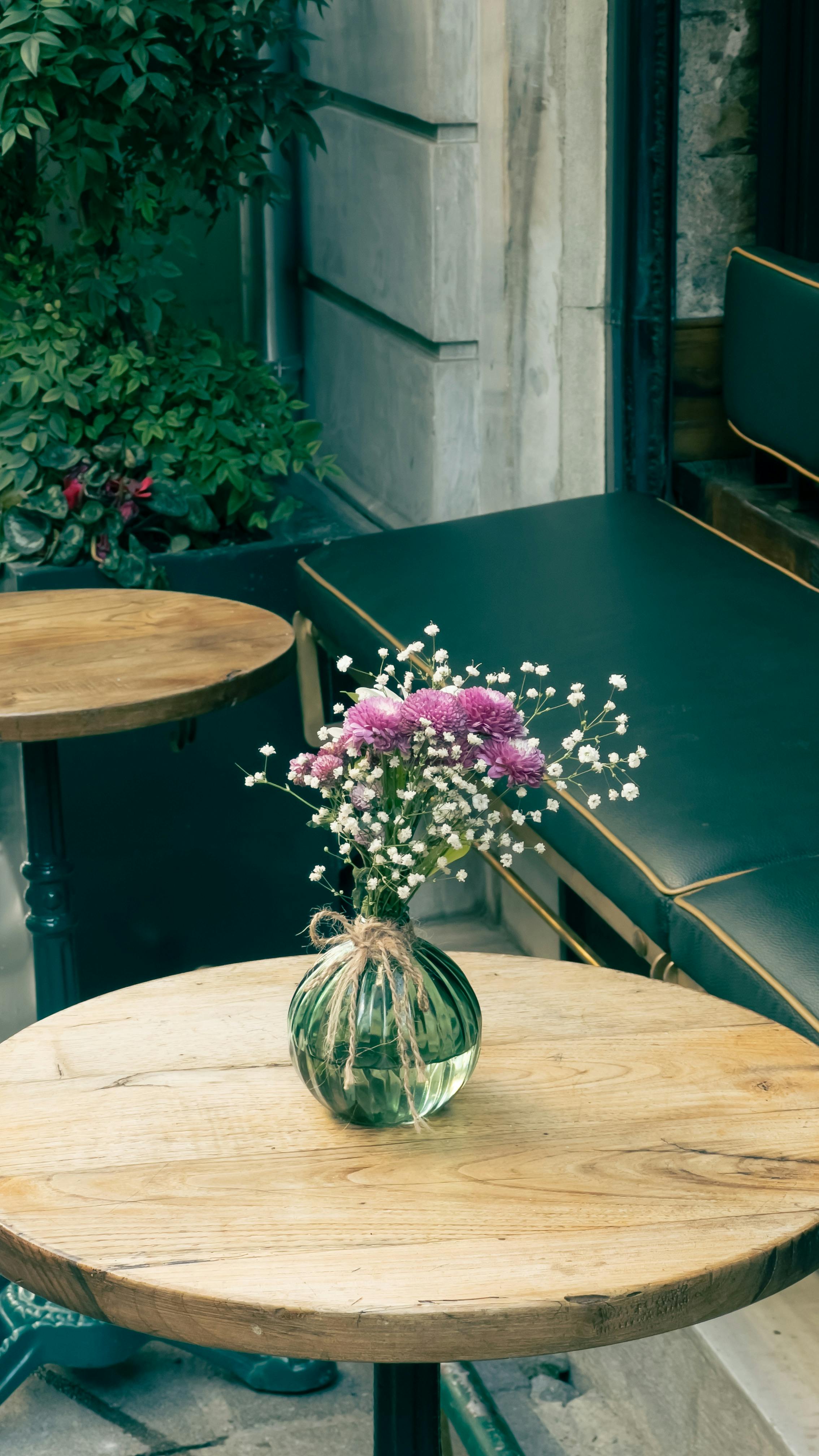 Rustic Outdoor Cafe Table with Floral Arrangement · Free Stock Photo