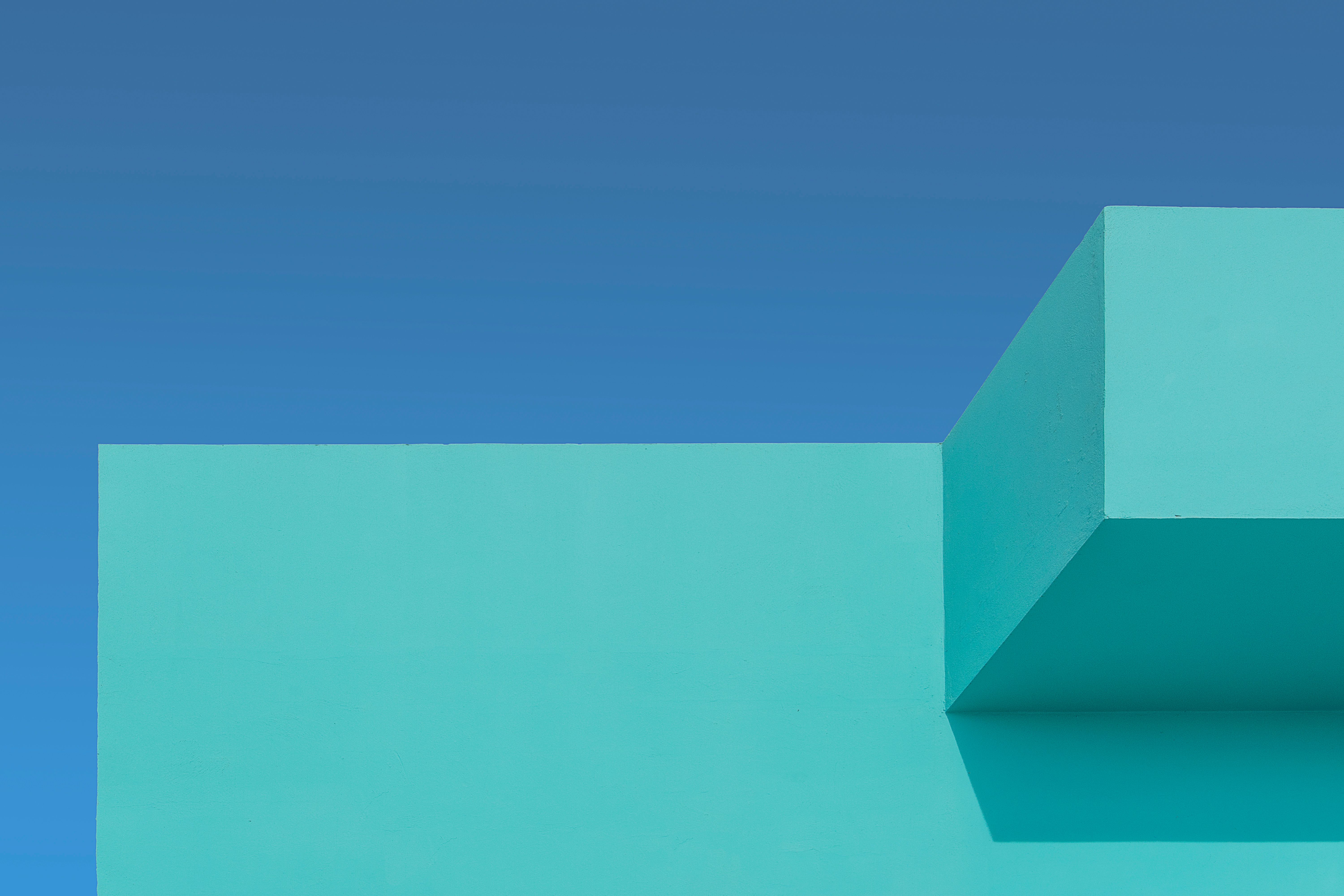 Minimalist turquoise building against clear sky · Free Stock Photo