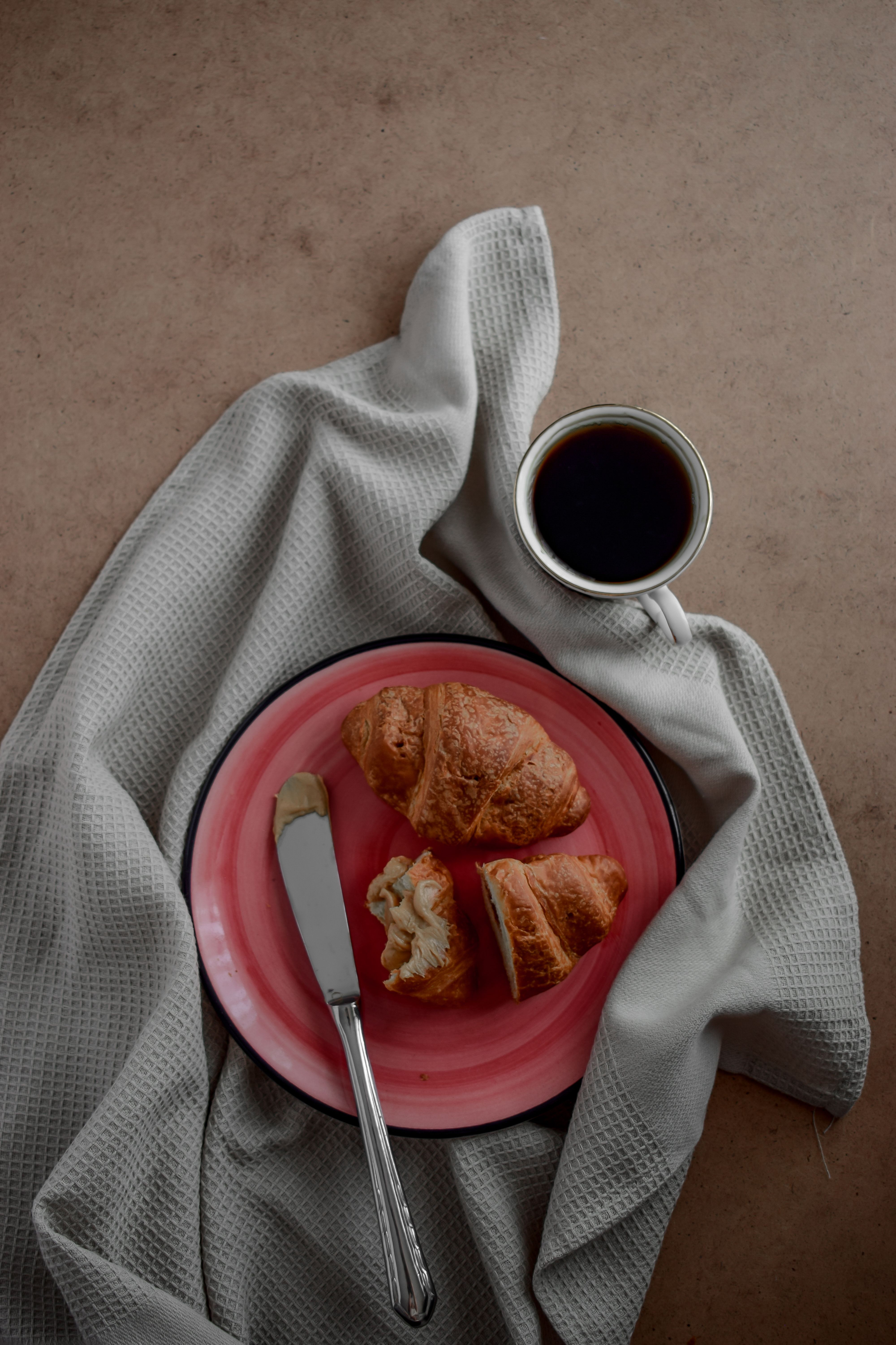 Elegant Breakfast Setting with Croissant and Coffee · Free Stock Photo