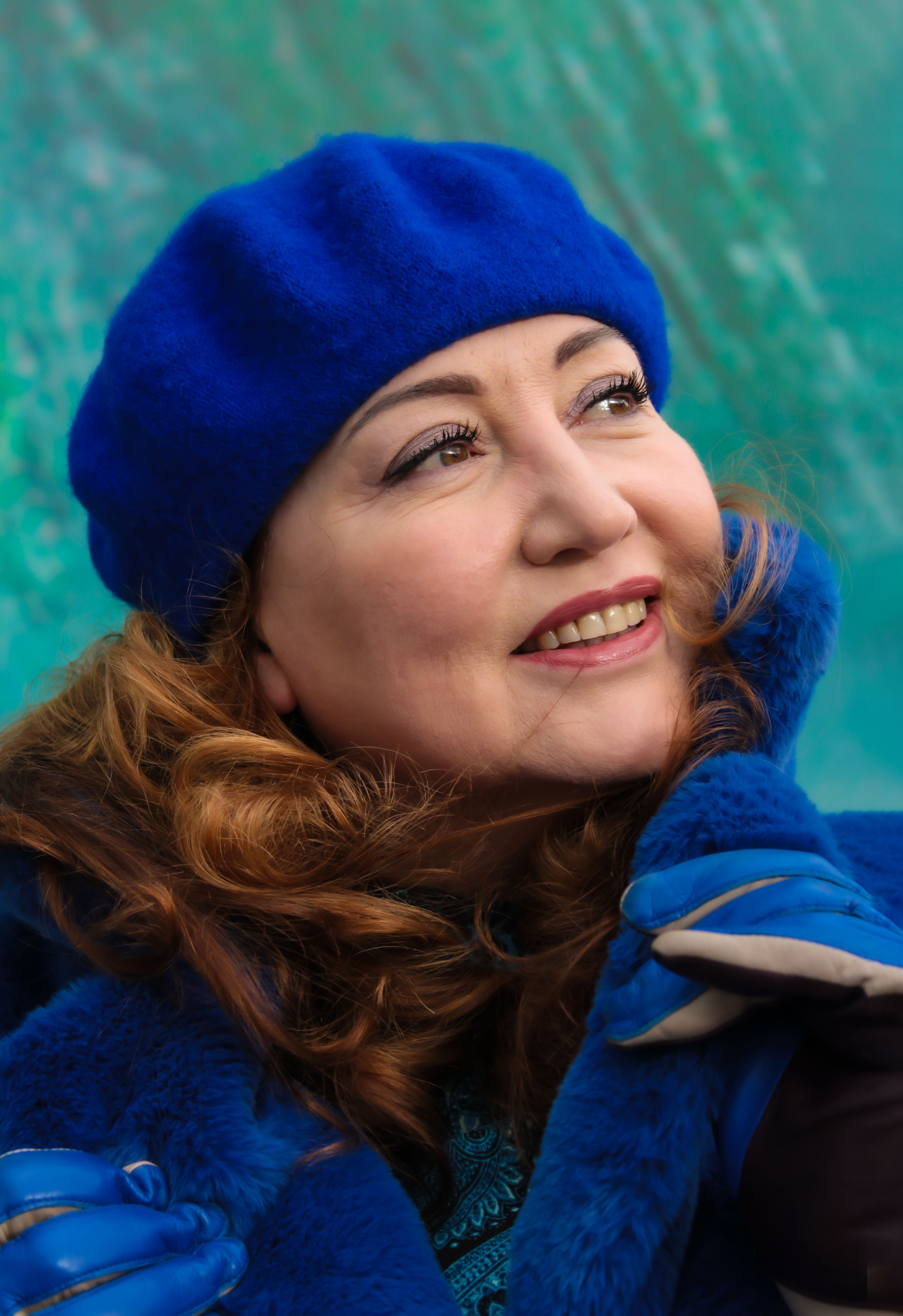 Elegant Woman in Blue Beret Smiling Outdoors · Free Stock Photo