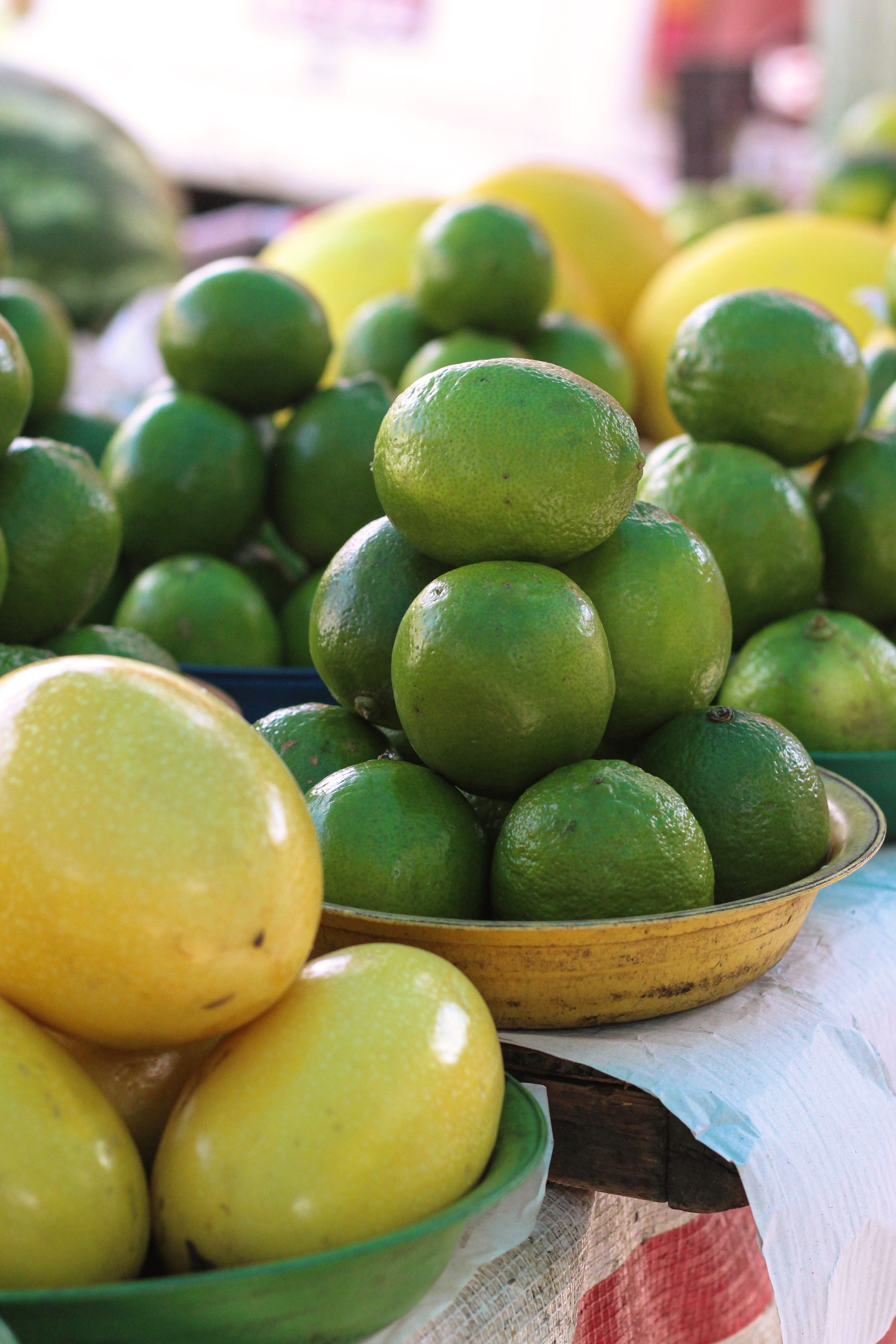 Vibrant Fresh Lemons and Limes Fruit Stand Display · Free Stock Photo
