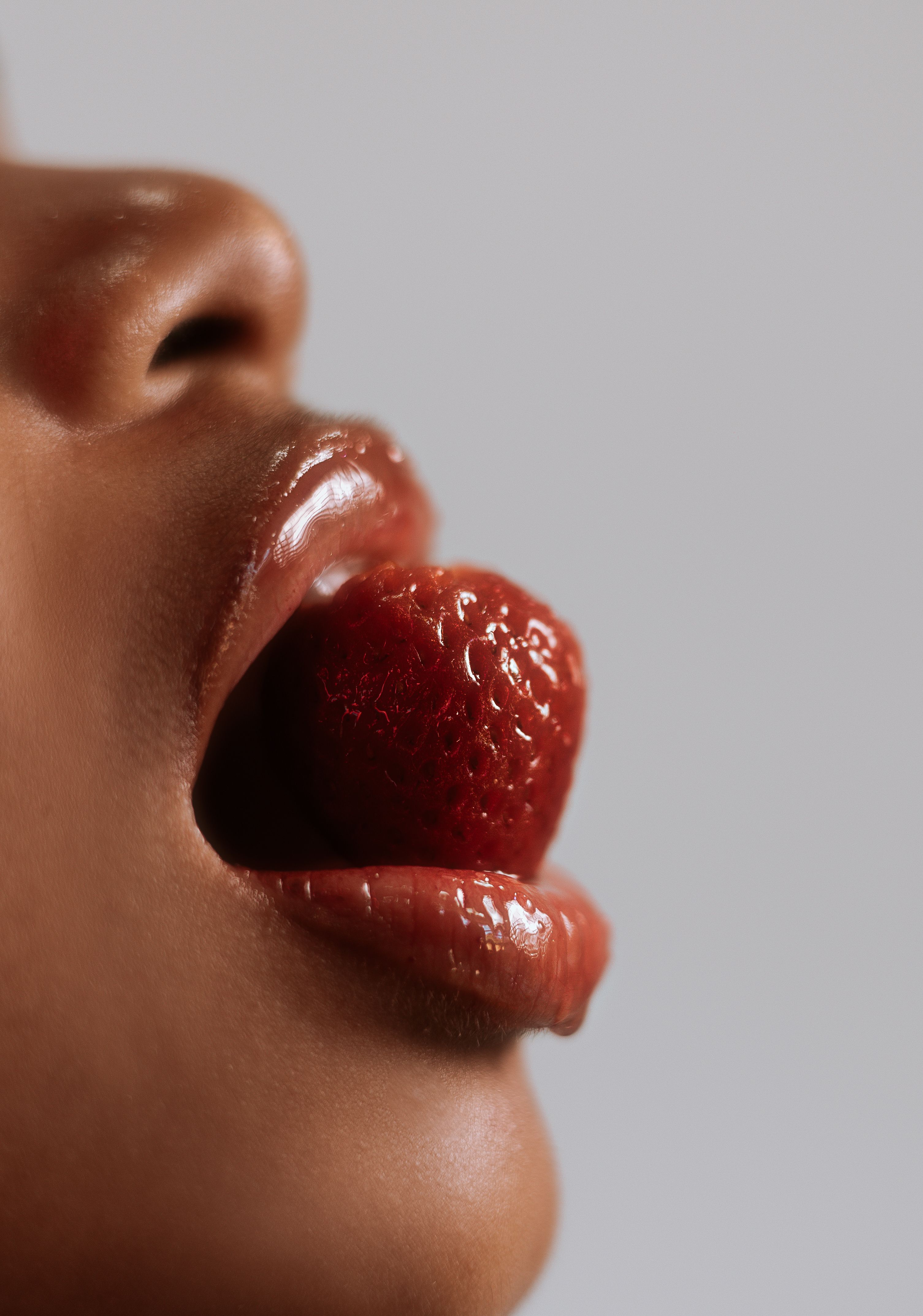 Close-up of a Strawberry on Lips · Free Stock Photo