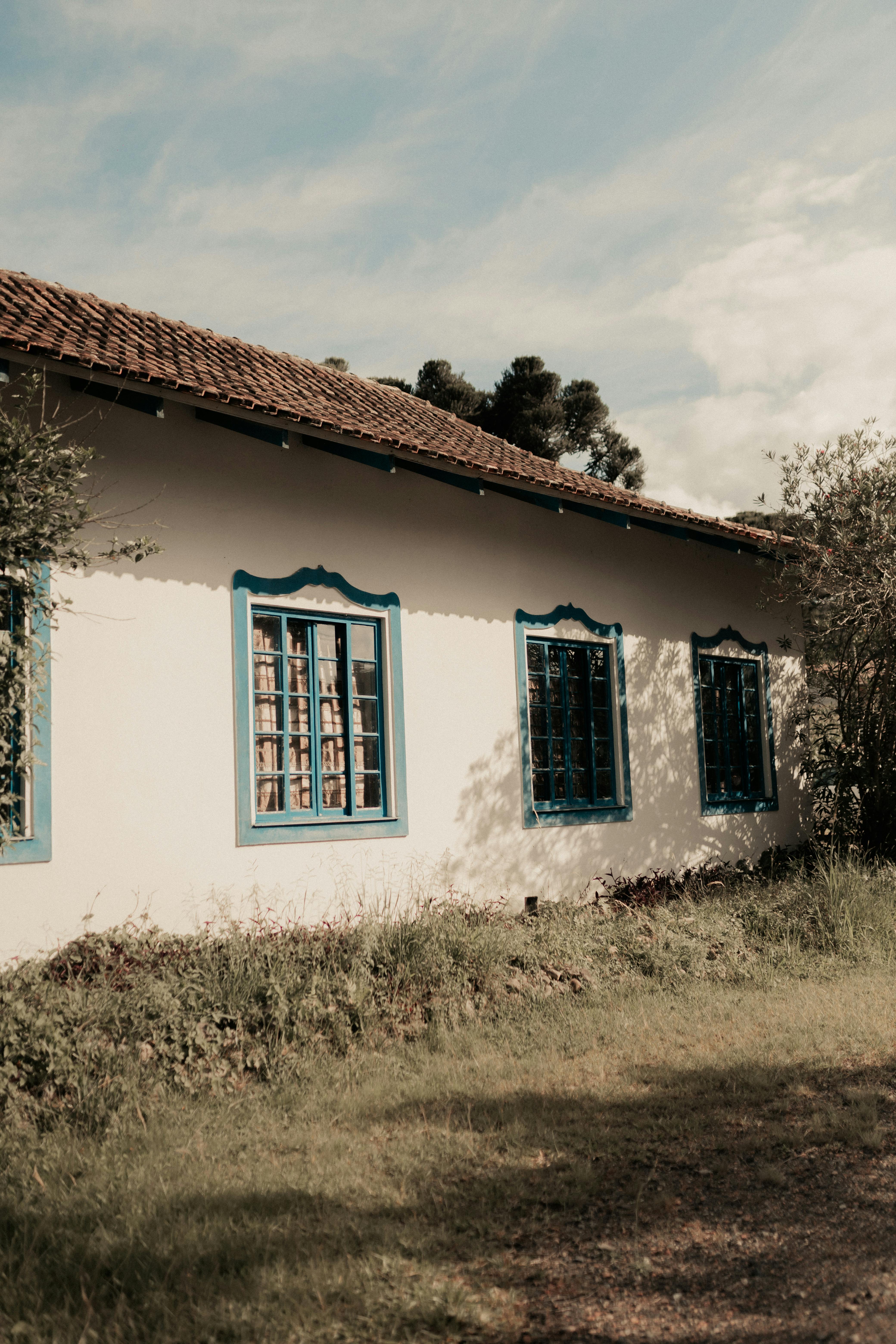 Charming Rustic House with Blue Trim in Countryside · Free Stock Photo