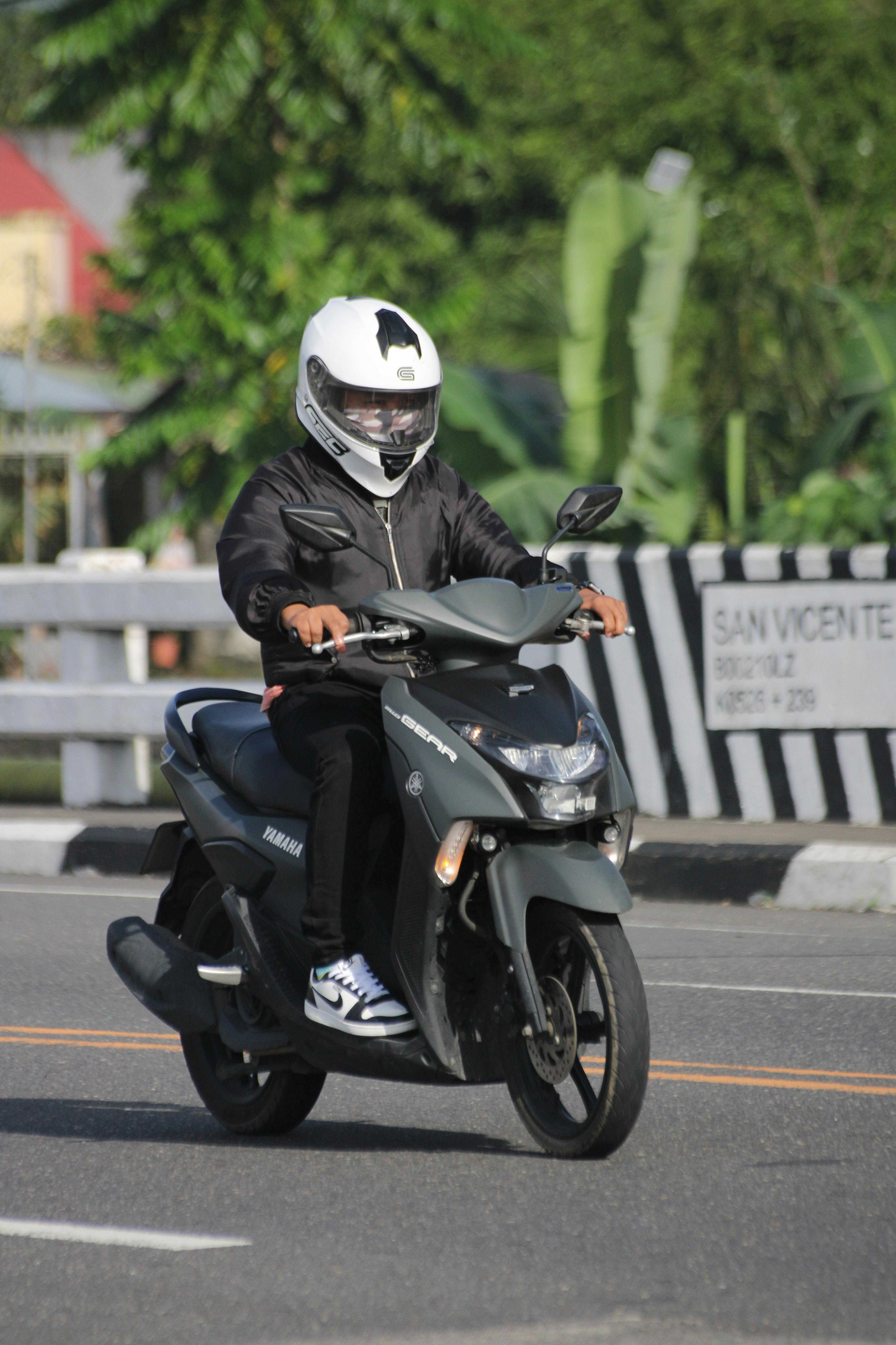Woman Riding Motor Scooter Travelling on Asphalt Road during Sunrise ...
