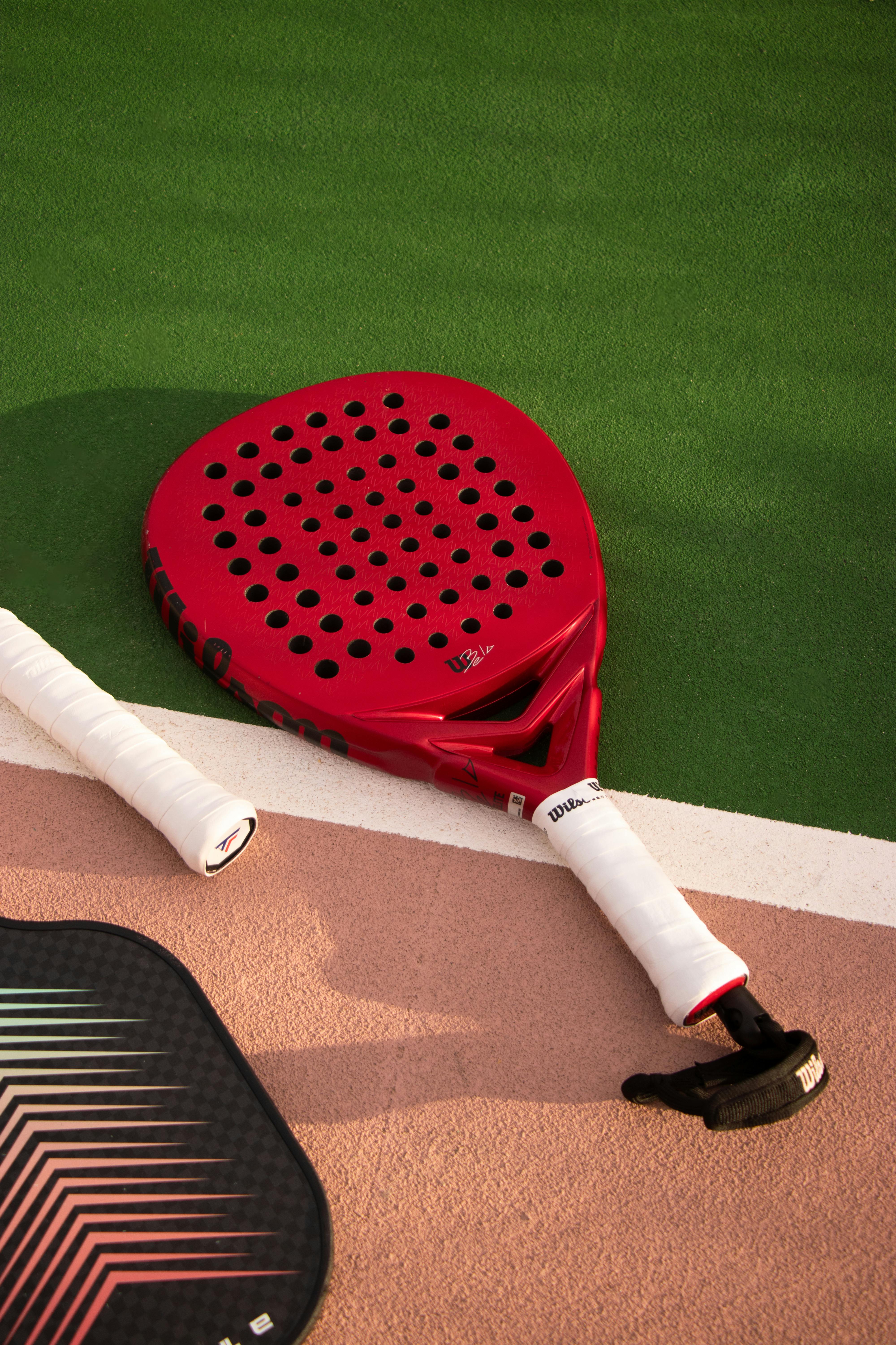 Red Padel Racket on Outdoor Court Surface · Free Stock Photo
