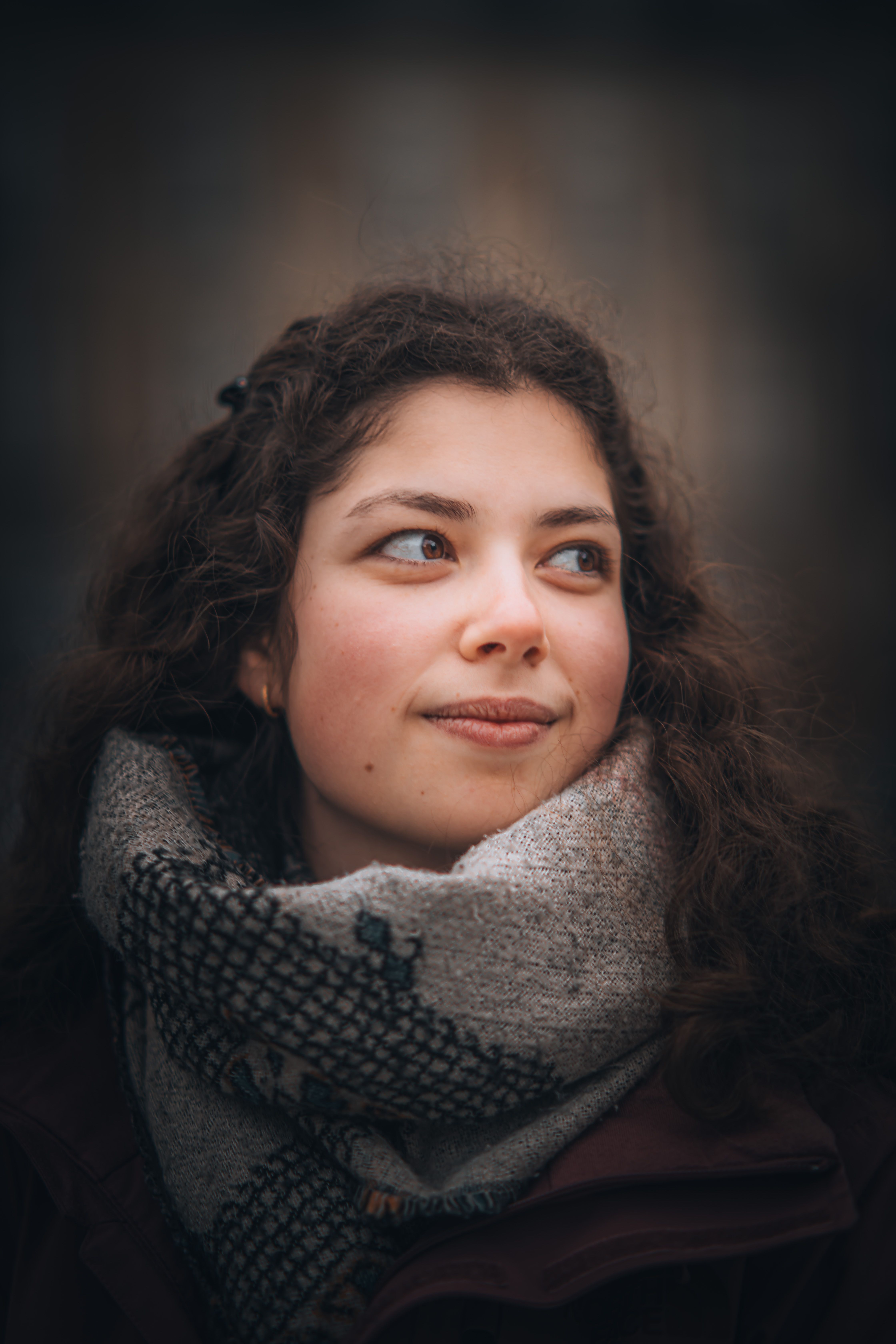 Warm Portrait of a Woman with Curly Hair · Free Stock Photo