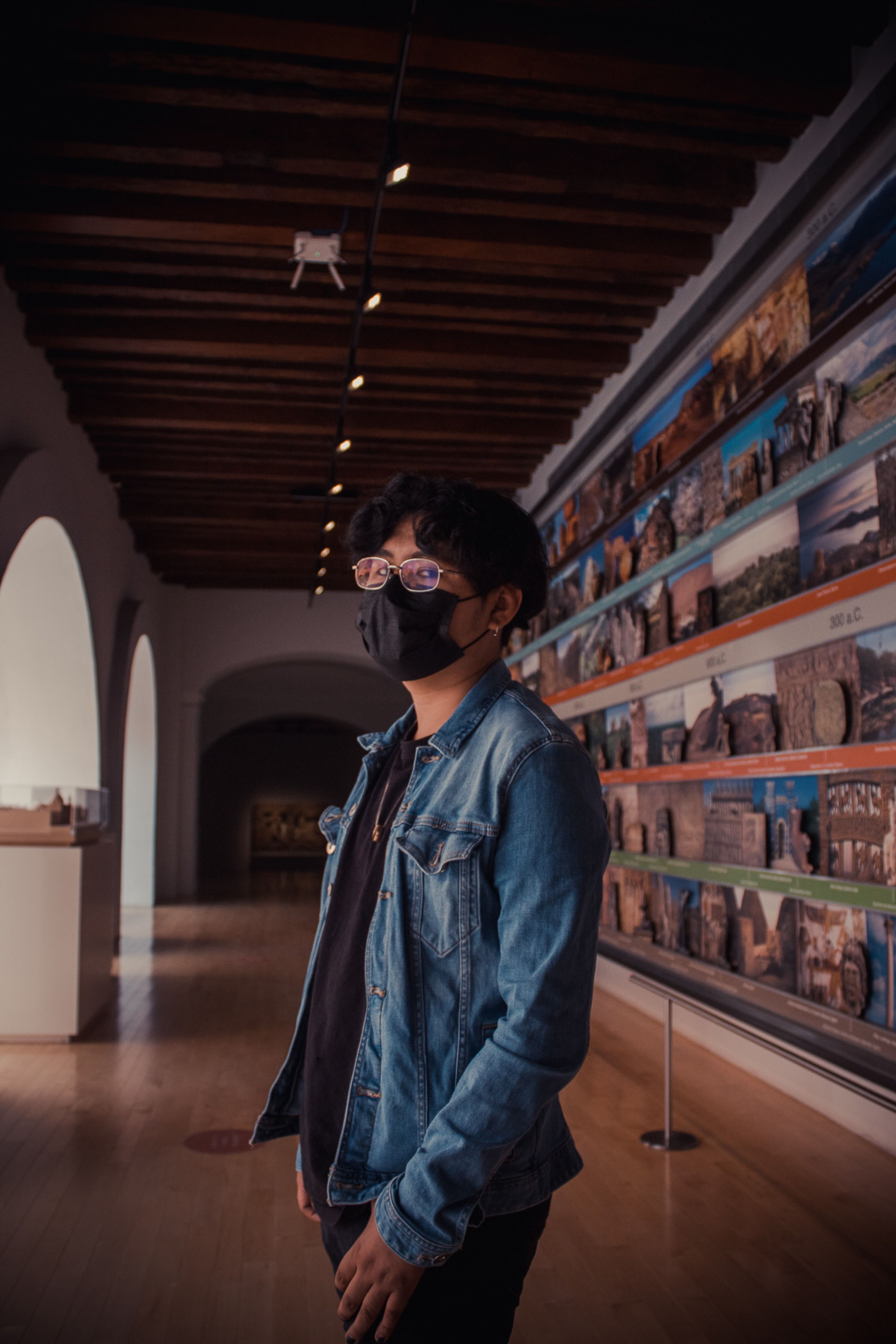 Man in Museum Wearing Denim Jacket and Mask · Free Stock Photo
