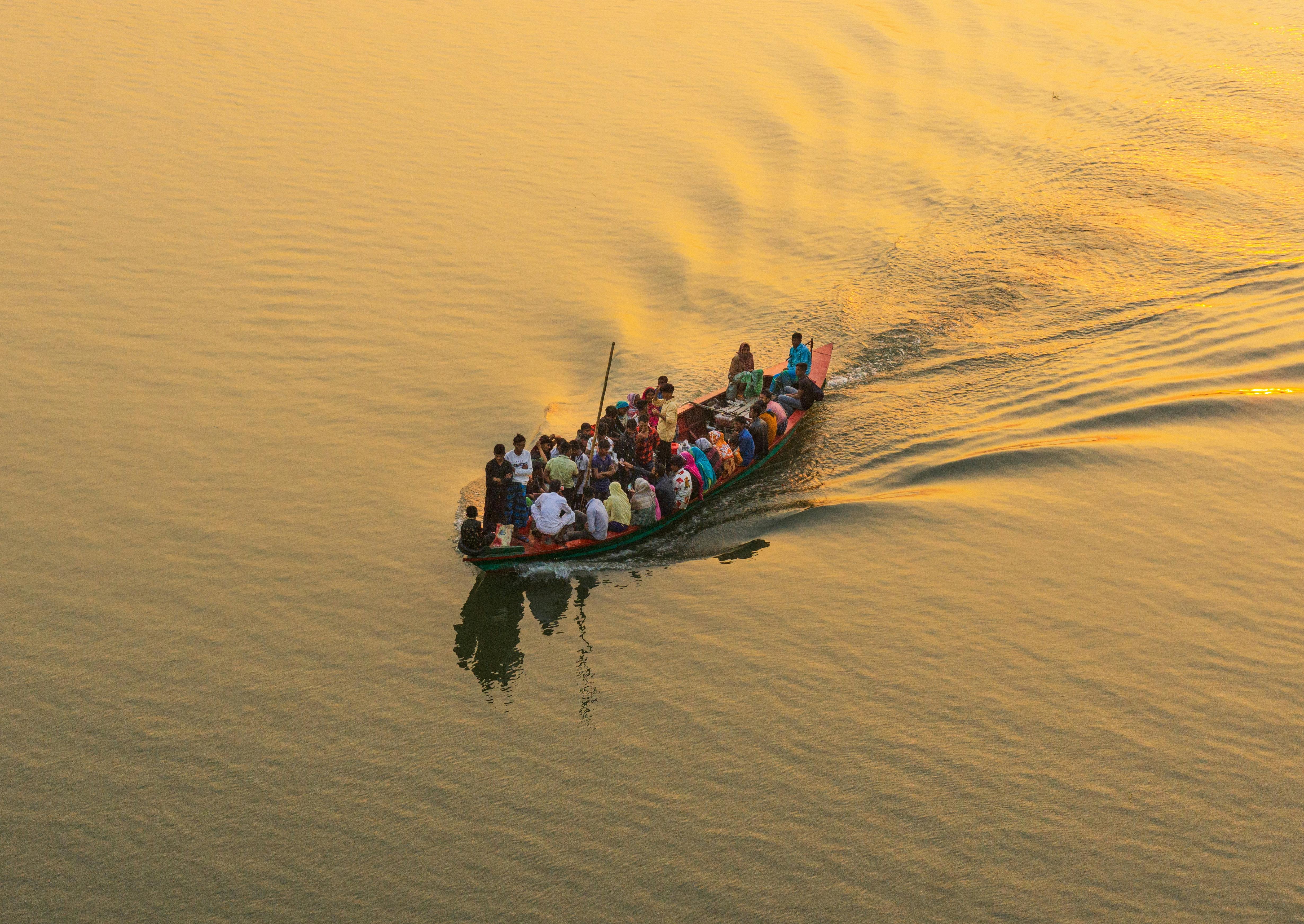 Crowded Boat on Serene River at Sunset · Free Stock Photo