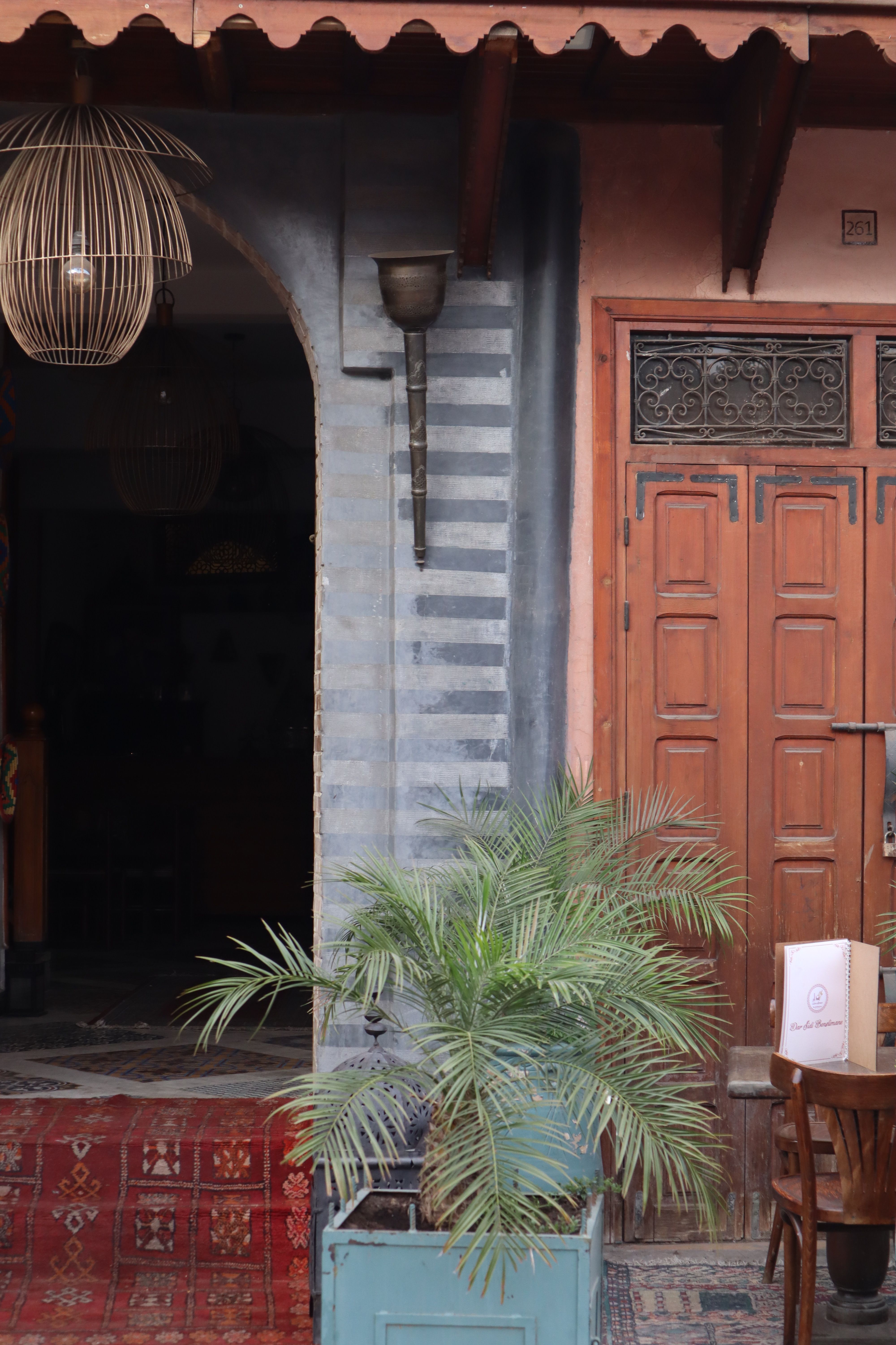 Charming Rustic Outdoor Cafe Entrance with Plant · Free Stock Photo