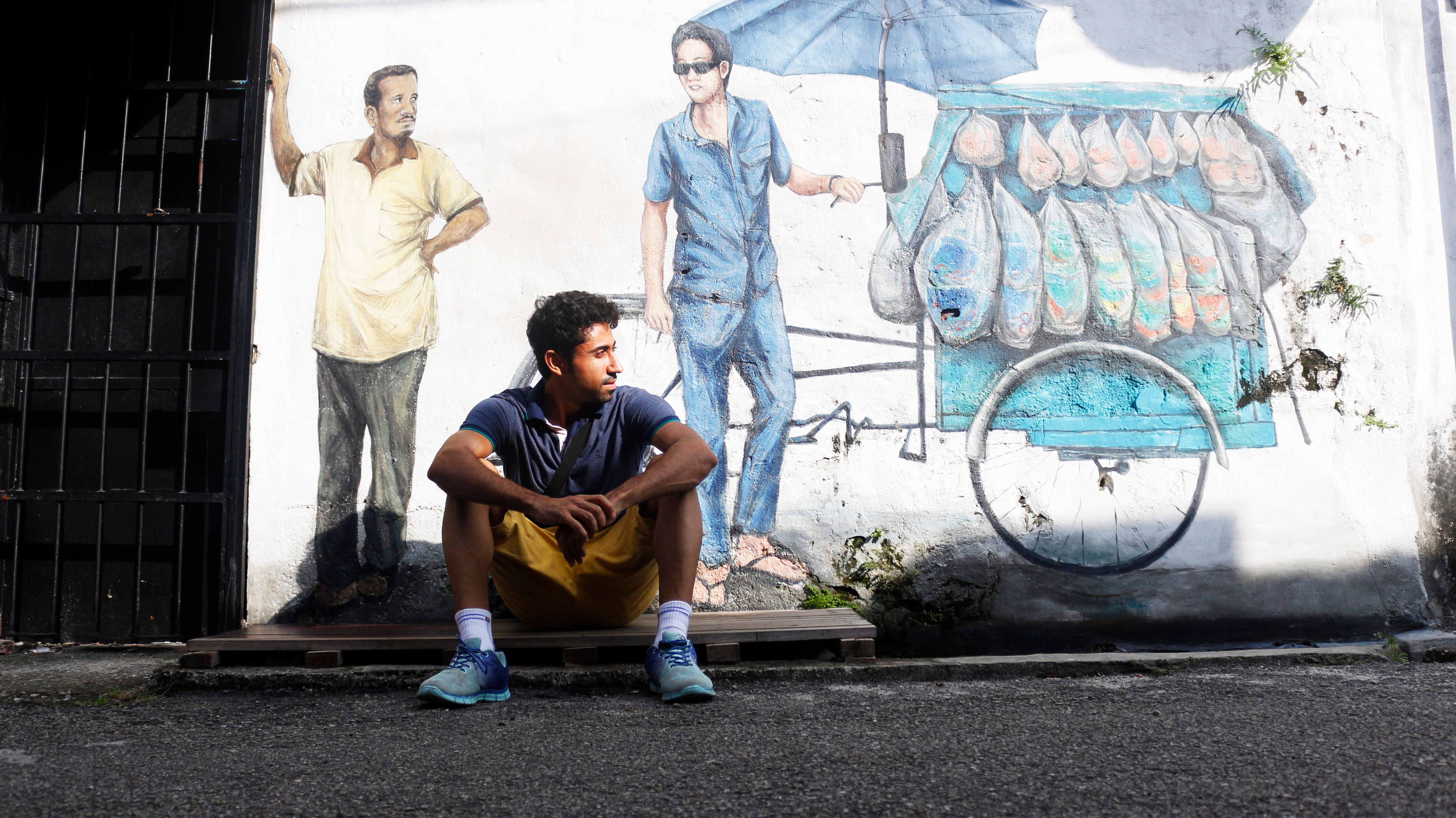 Street Art in Penang: A Man and Mural · Free Stock Photo