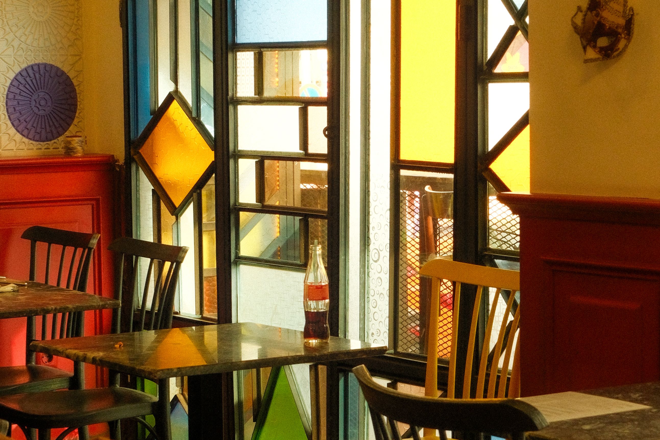 Cozy cafe interior with stained glass windows · Free Stock Photo