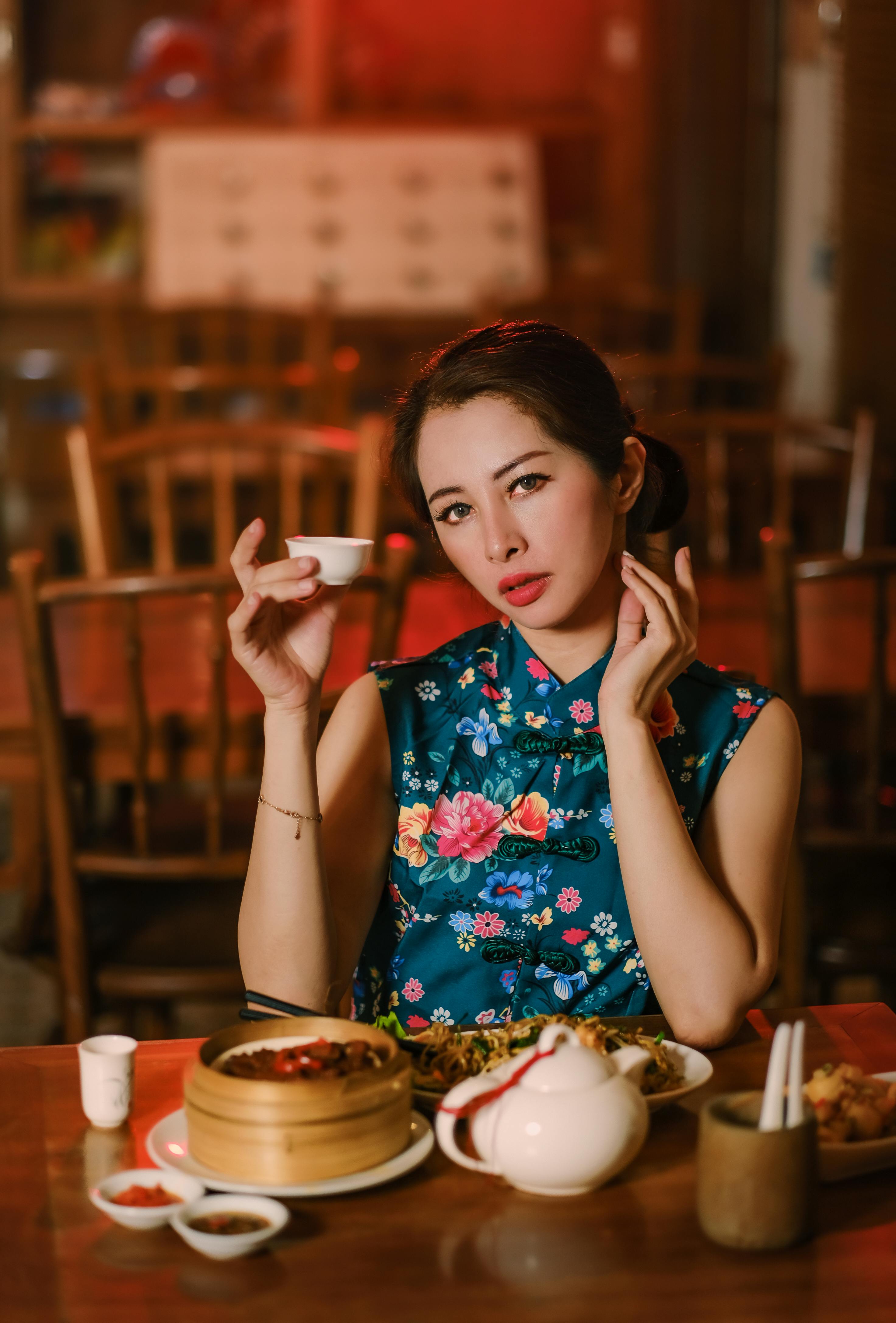 Elegant Woman Enjoying Tea in Traditional Setting · Free Stock Photo