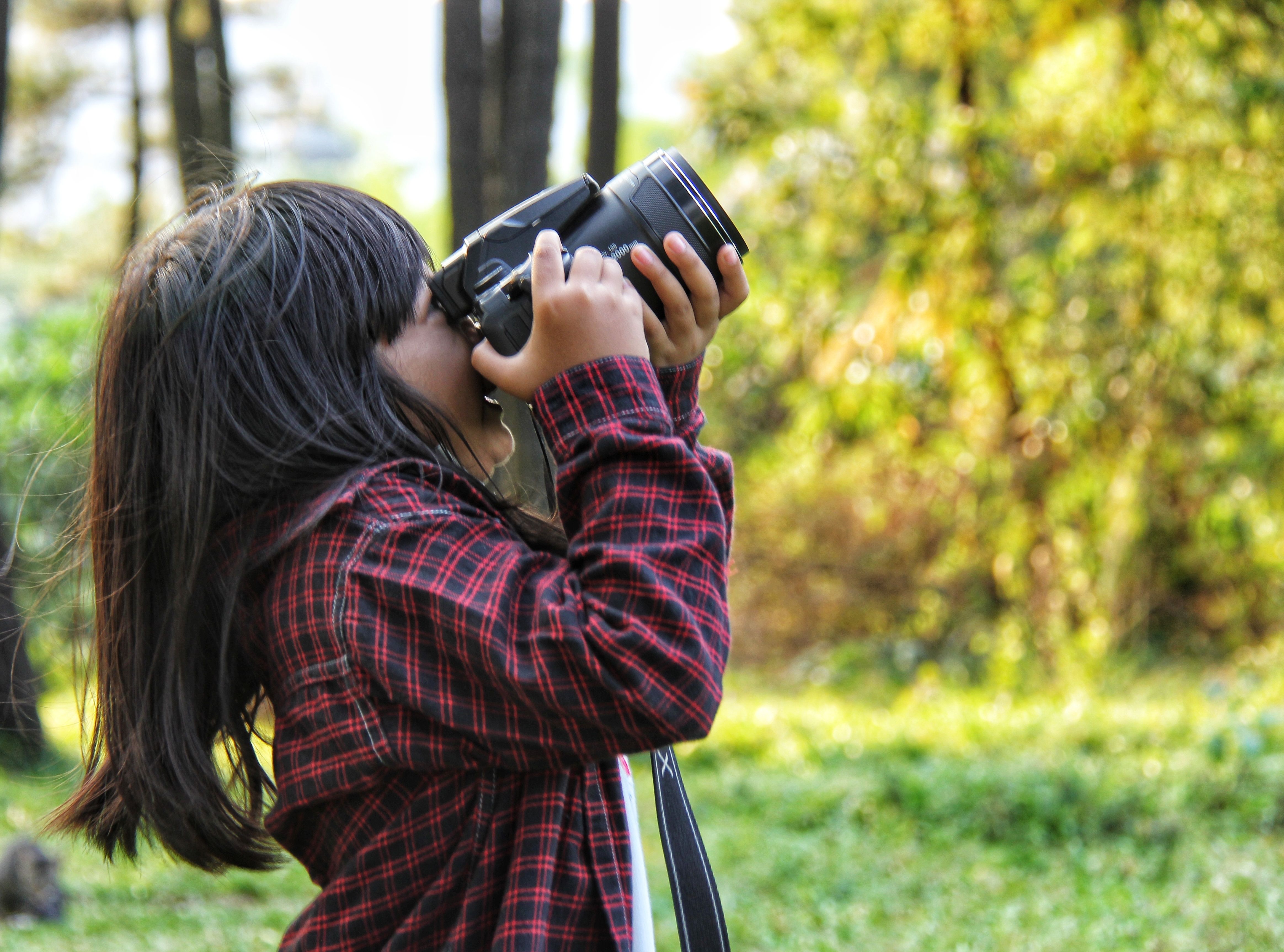 Young Girl Exploring Nature with Binoculars · Free Stock Photo