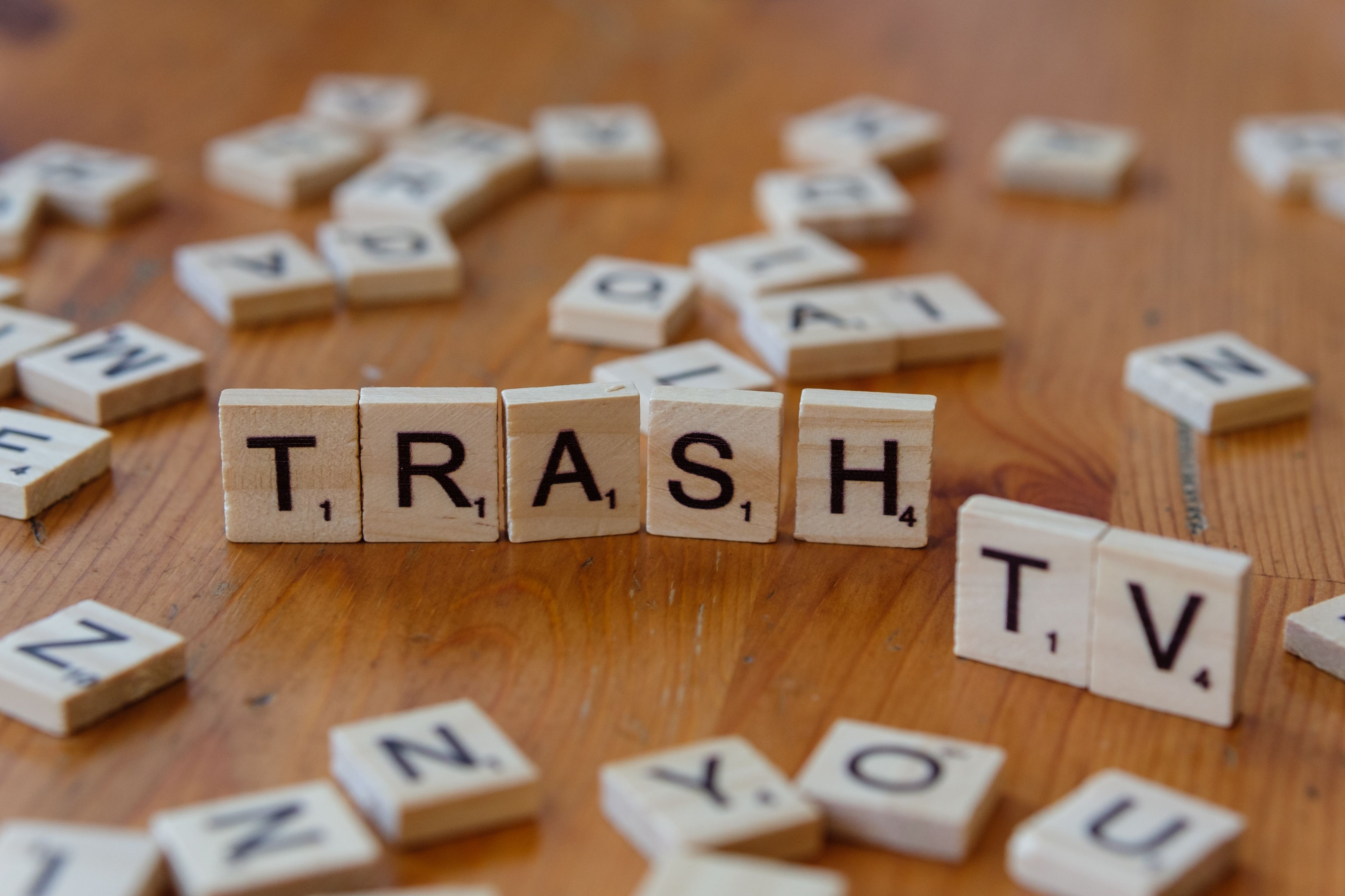 Scrabble Letters Spelling 'Trash TV' on Wooden Surface · Free Stock Photo