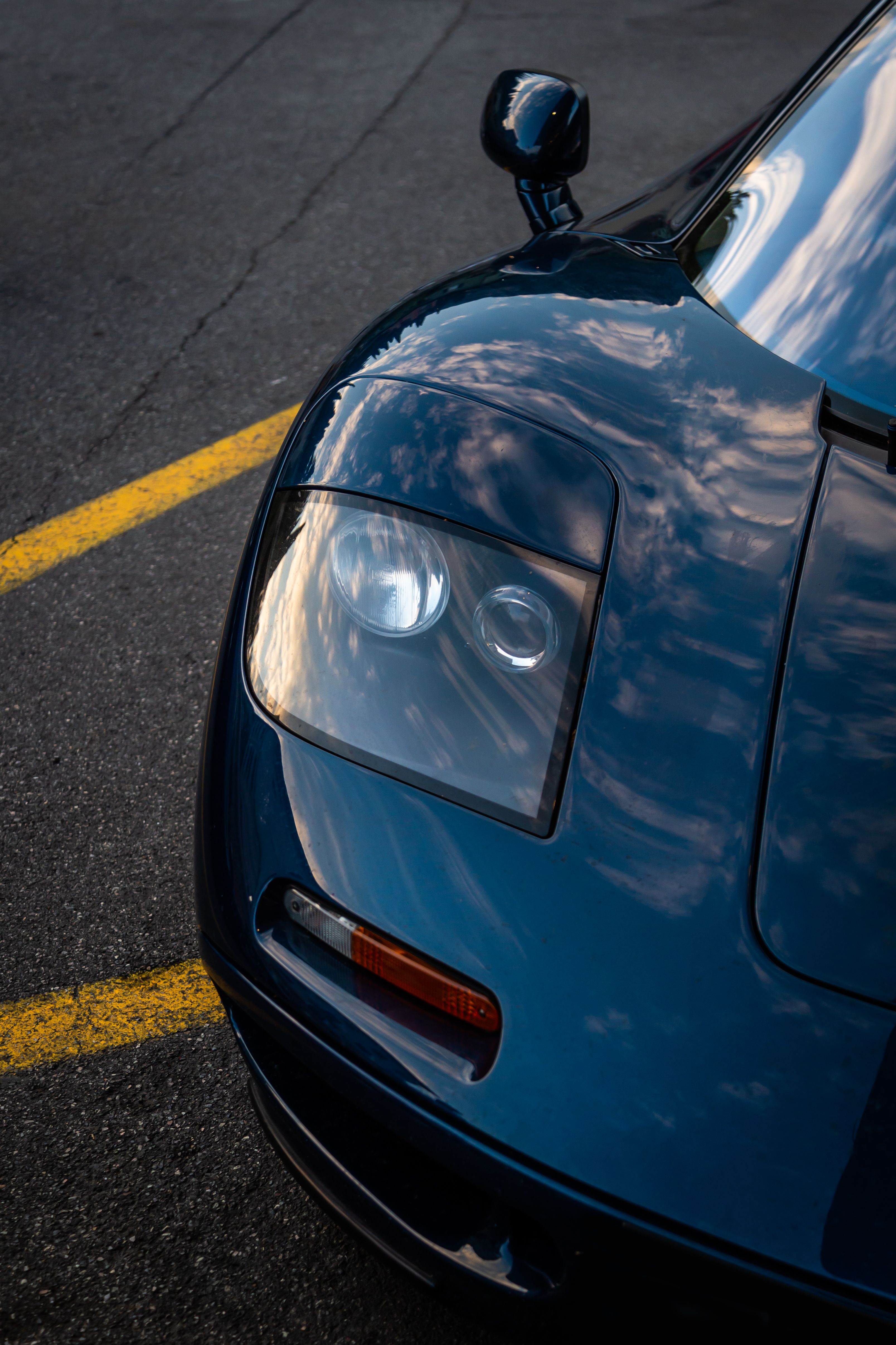 Sleek Supercar with Reflections at Sunset · Free Stock Photo