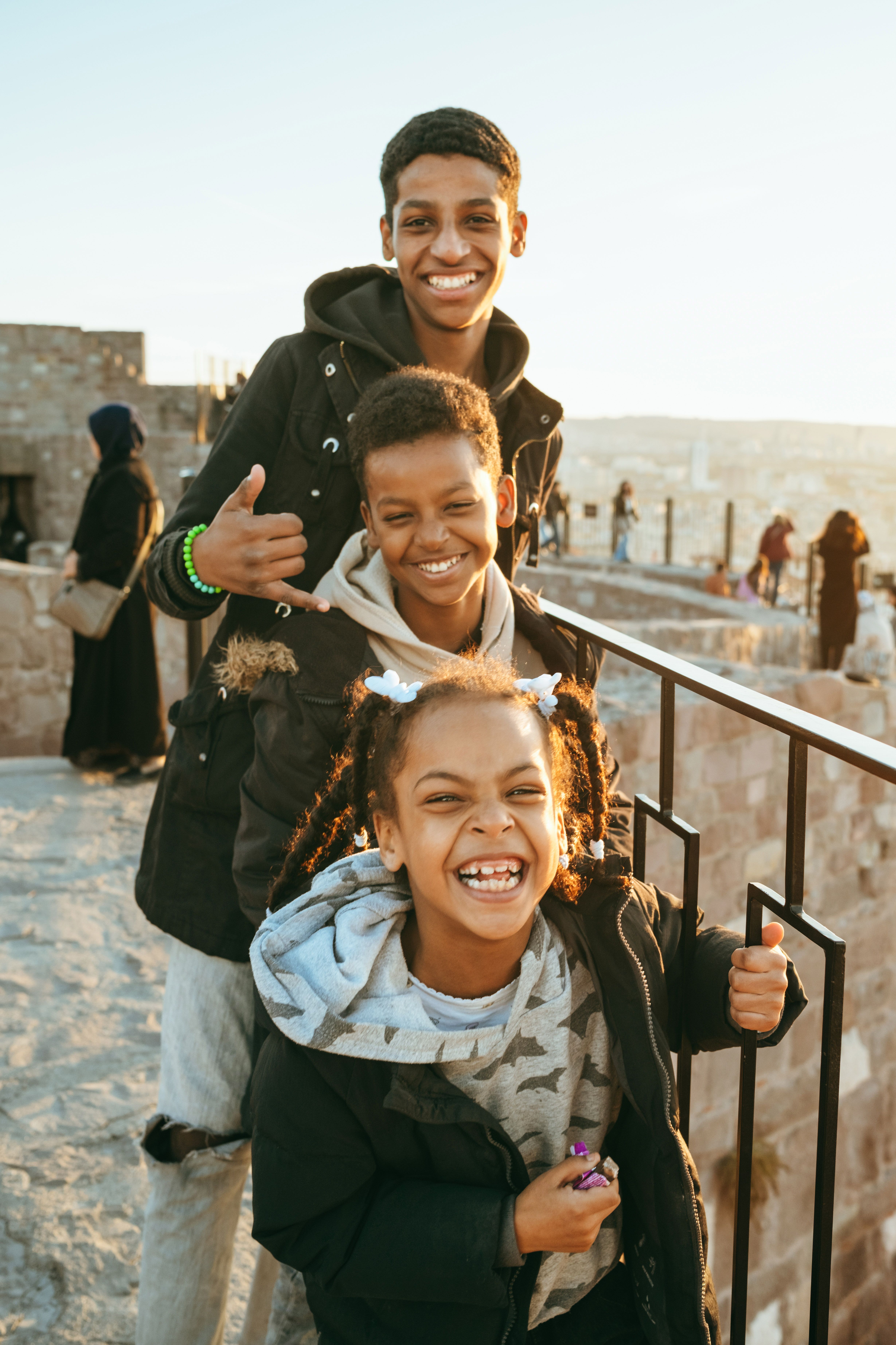 Joyful Siblings Smiling on a Sunny Day · Free Stock Photo