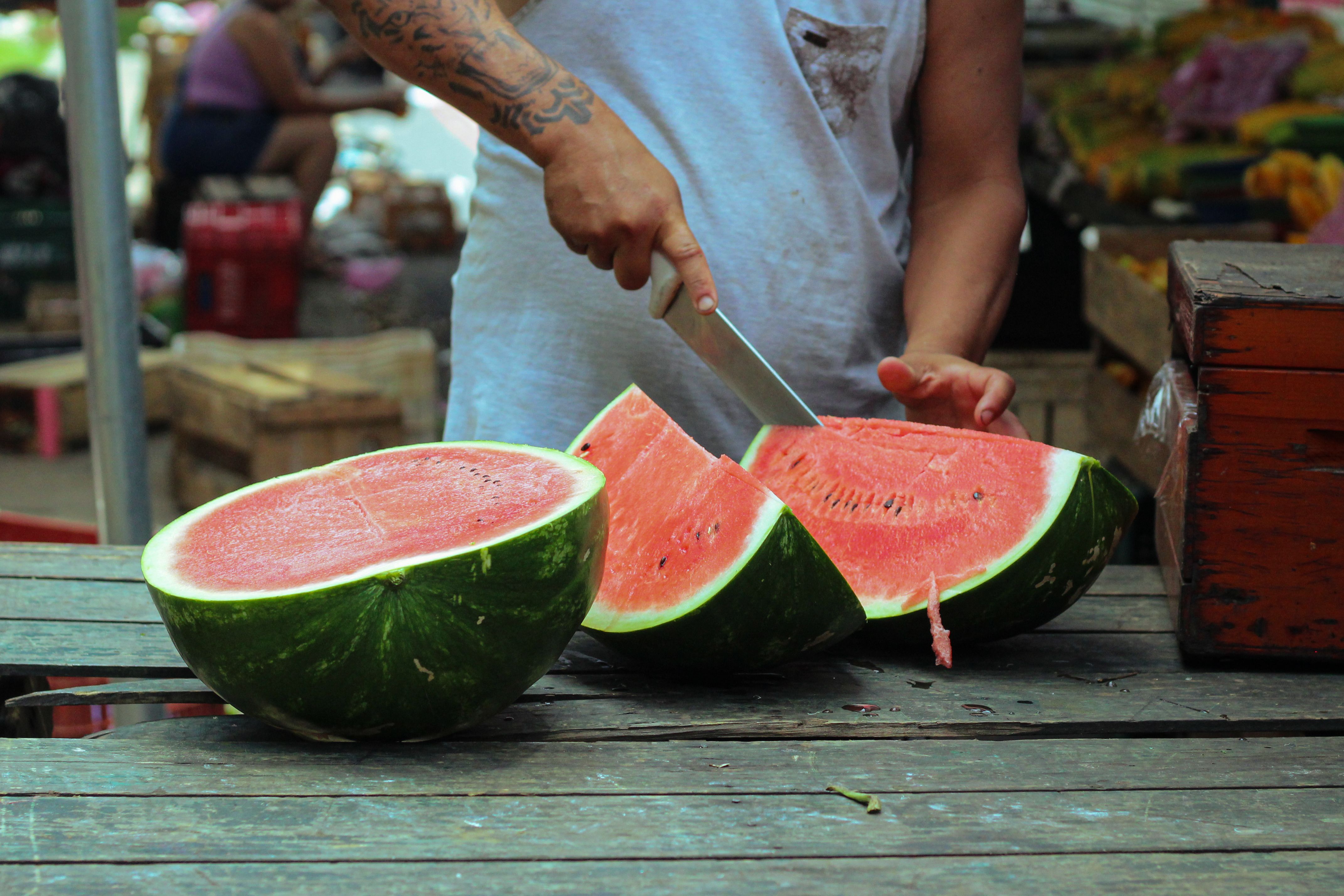 Cutting Fresh Watermelon at Outdoor Market · Free Stock Photo