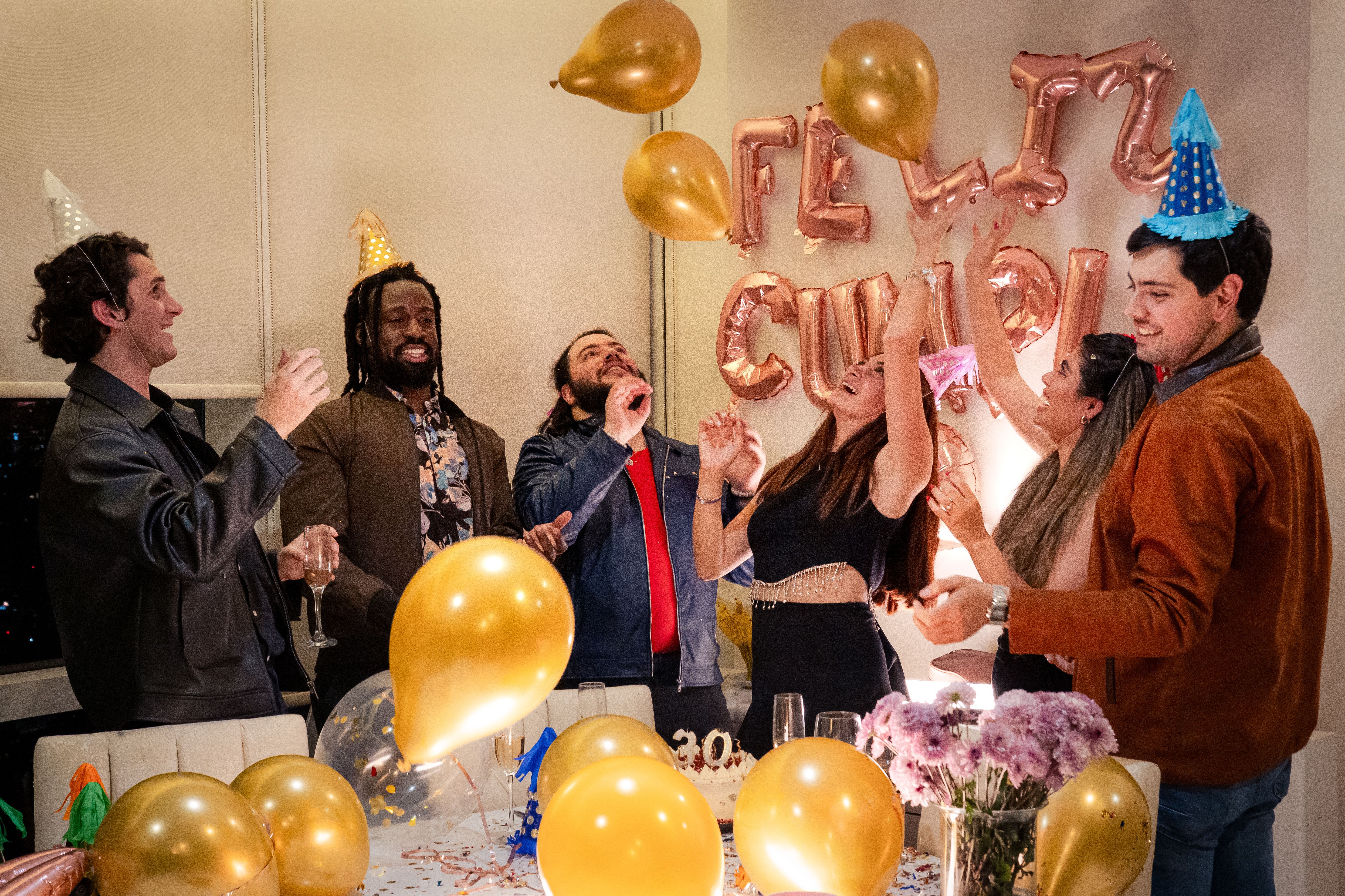 Joyful Birthday Celebration with Friends and Balloons · Free Stock Photo