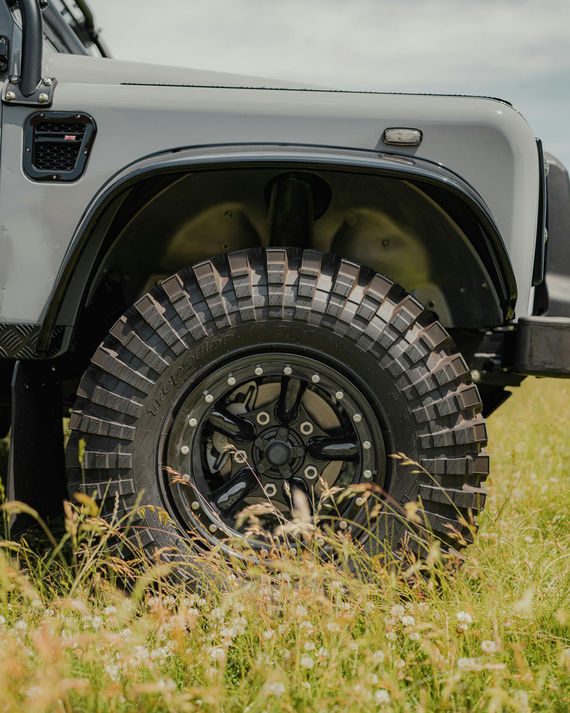 Off-Road Vehicle in Meadow with Rugged Tires · Free Stock Photo