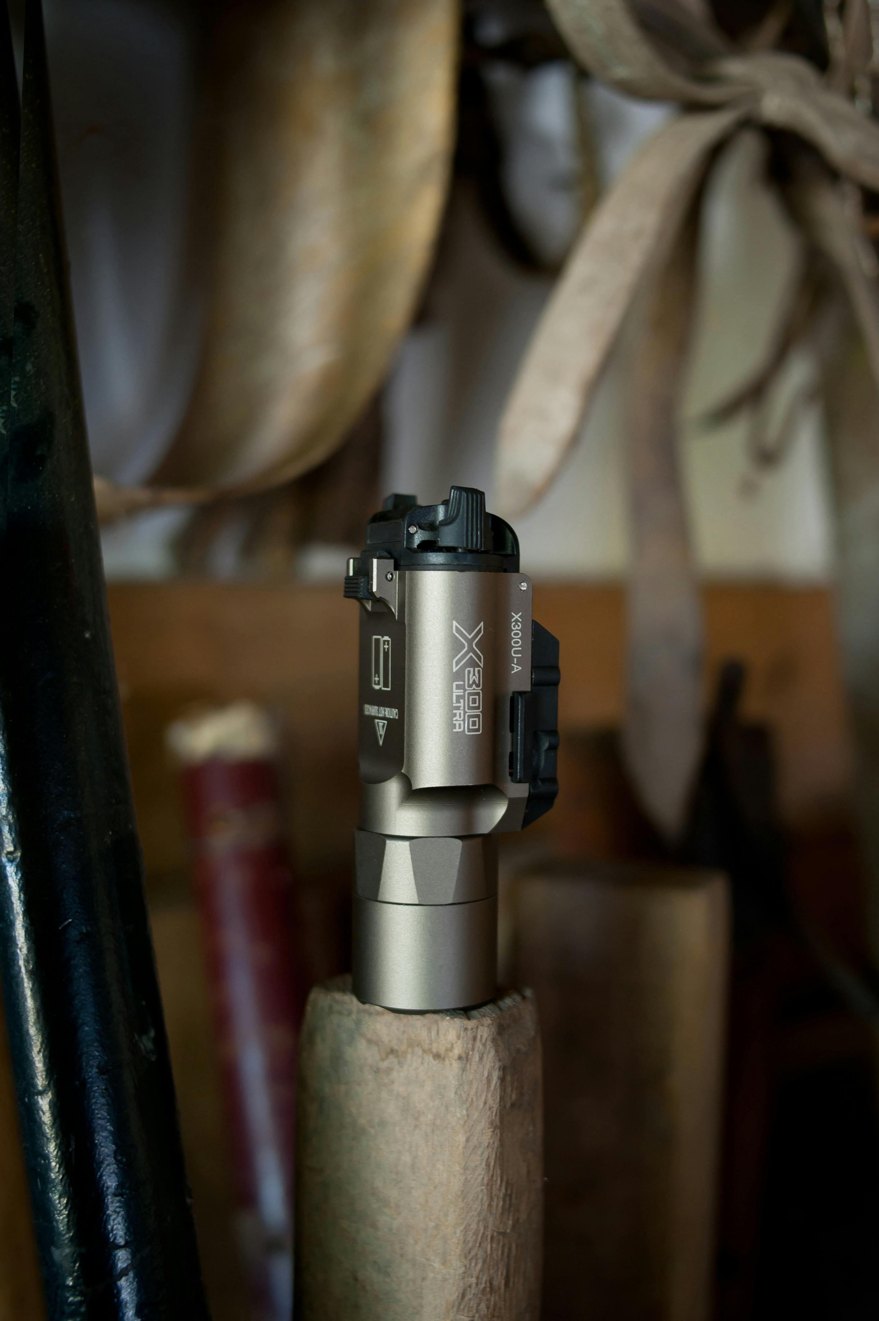 High-Tech Flashlight on Rustic Background · Free Stock Photo