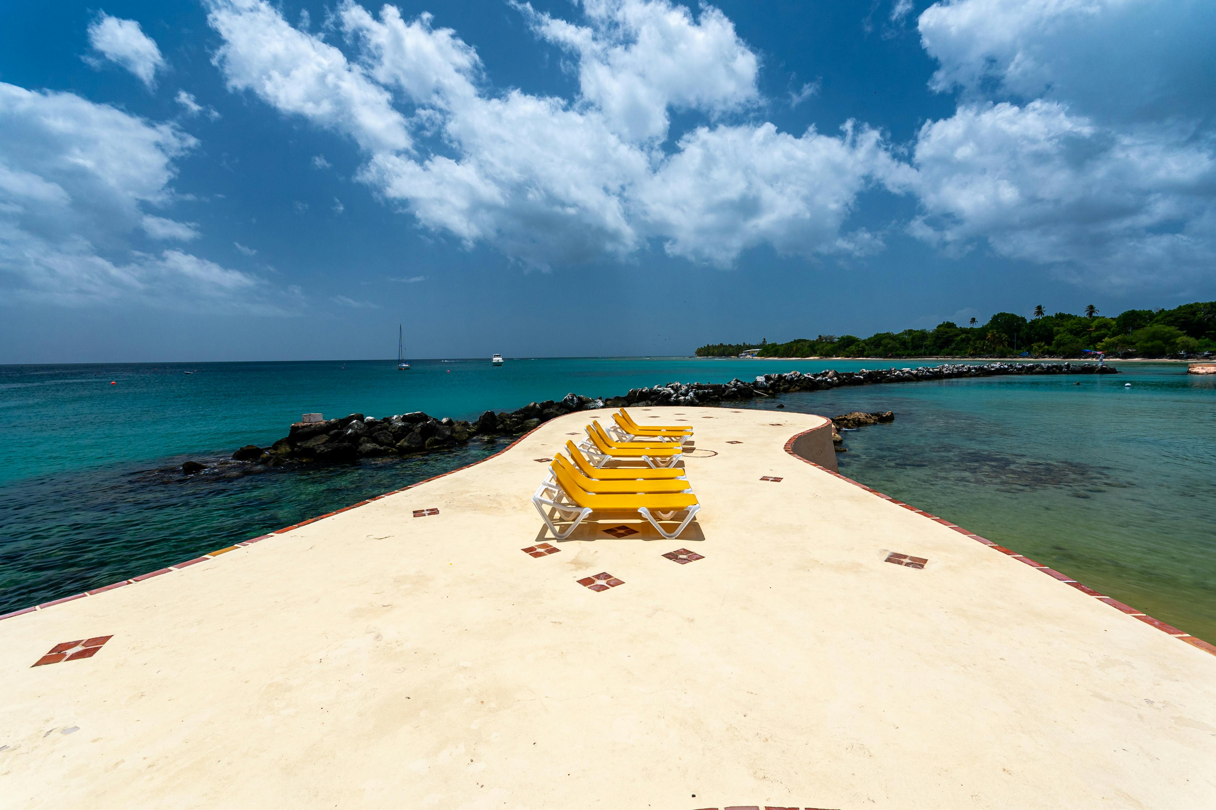 Scenic Beachfront with Yellow Chairs in Tobago · Free Stock Photo