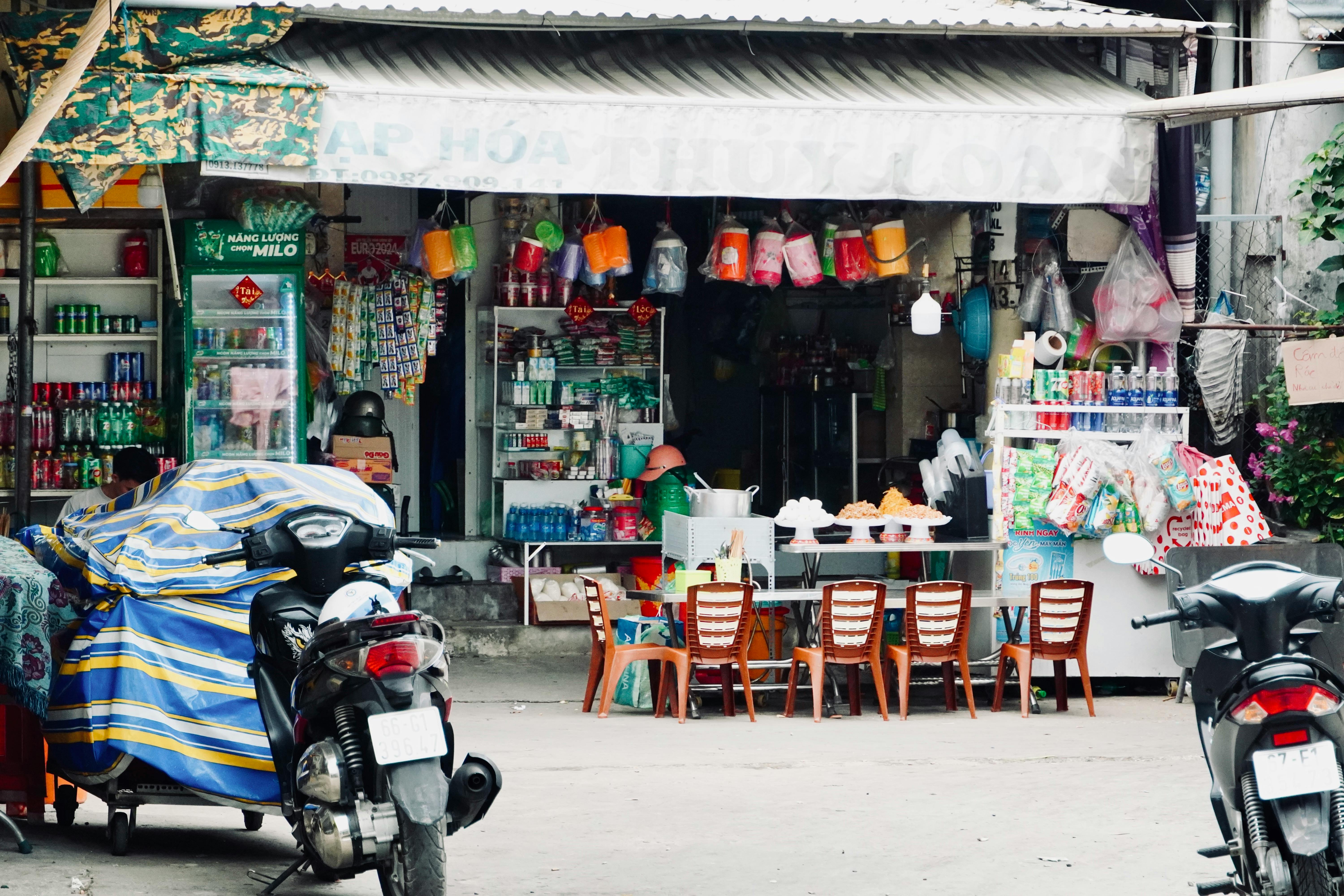 Colorful Street Market Scene with Motorcycles · Free Stock Photo