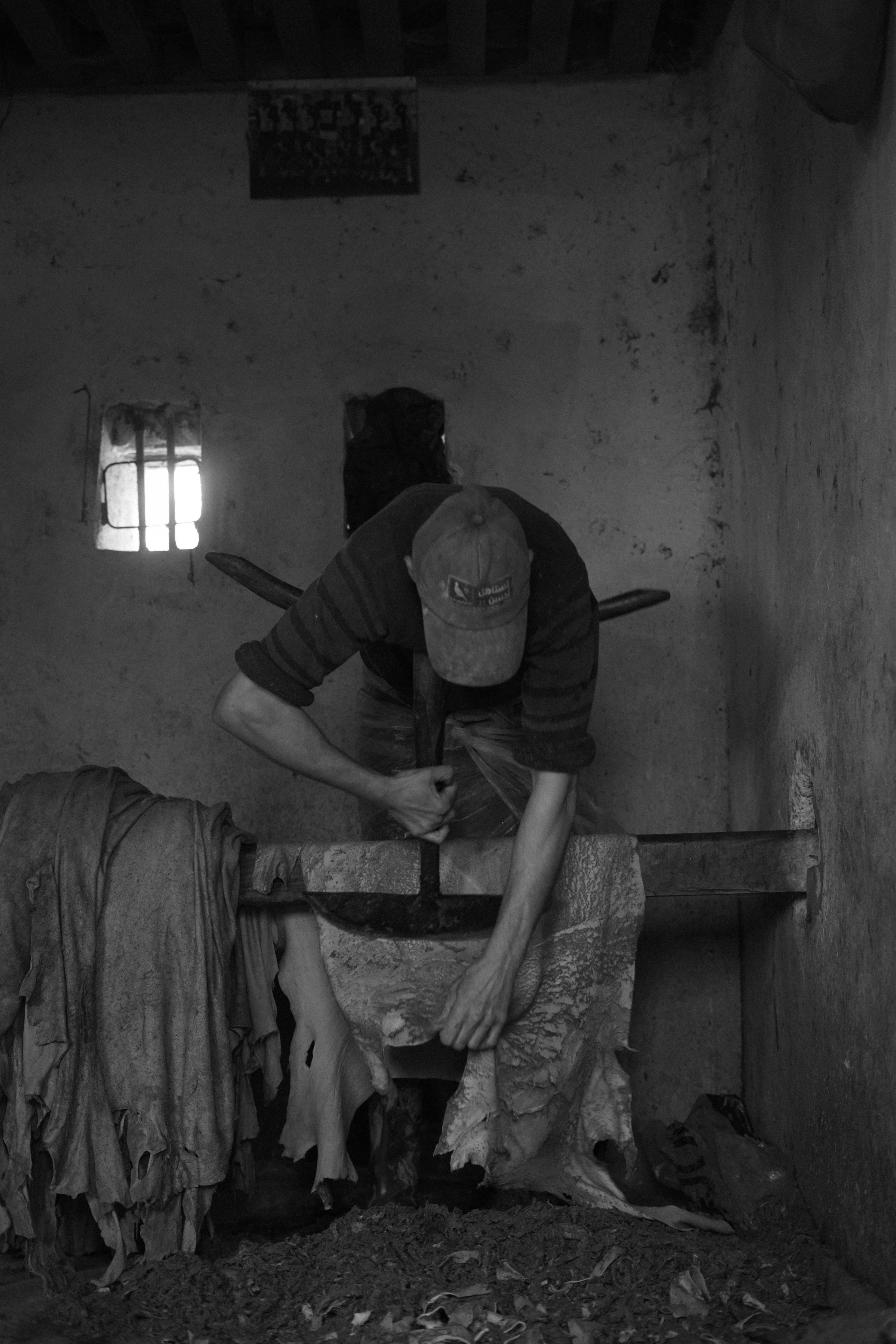 Artisanal Leather Tanning in Rustic Workshop · Free Stock Photo