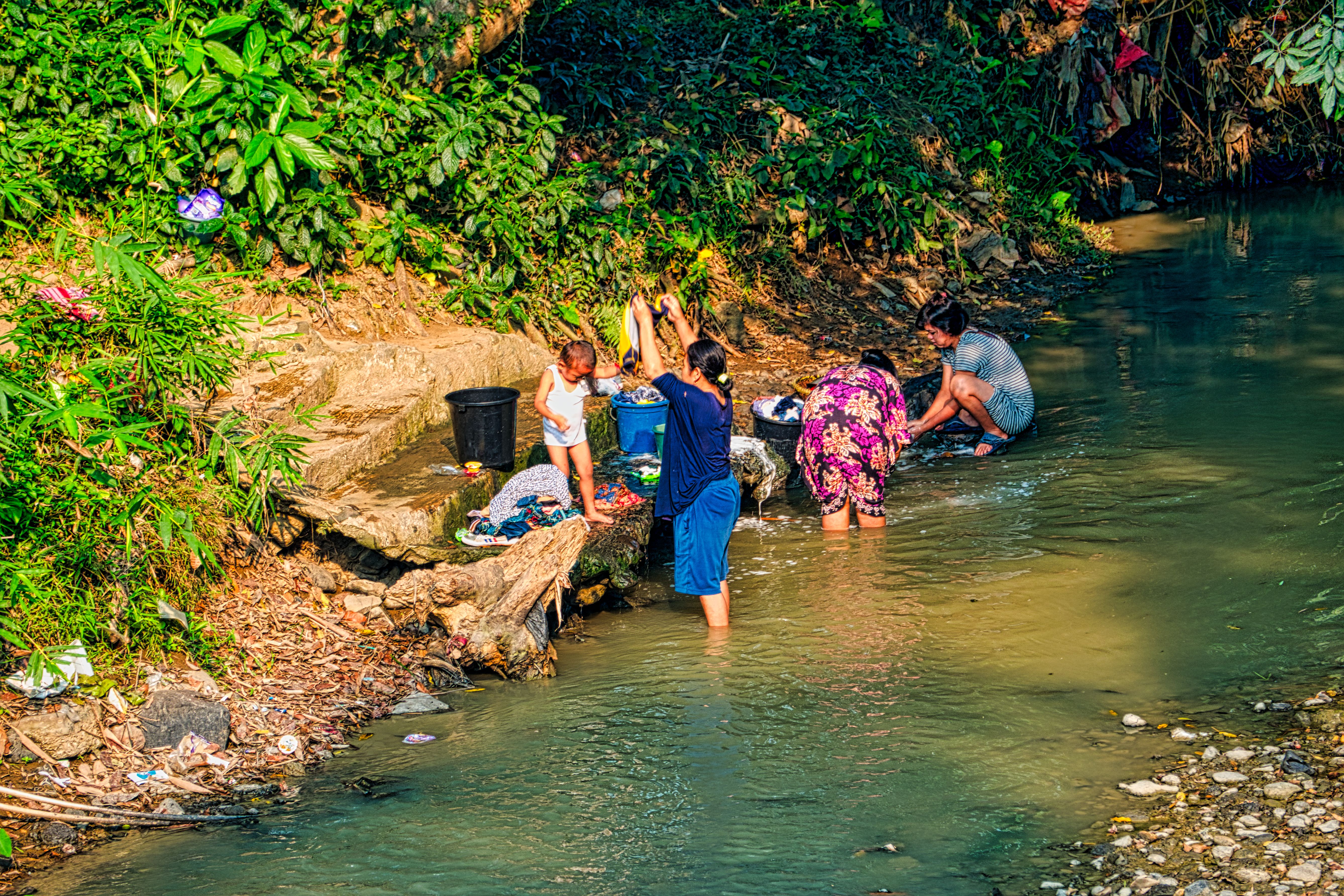 Women Washing Clothes by the River · Free Stock Photo
