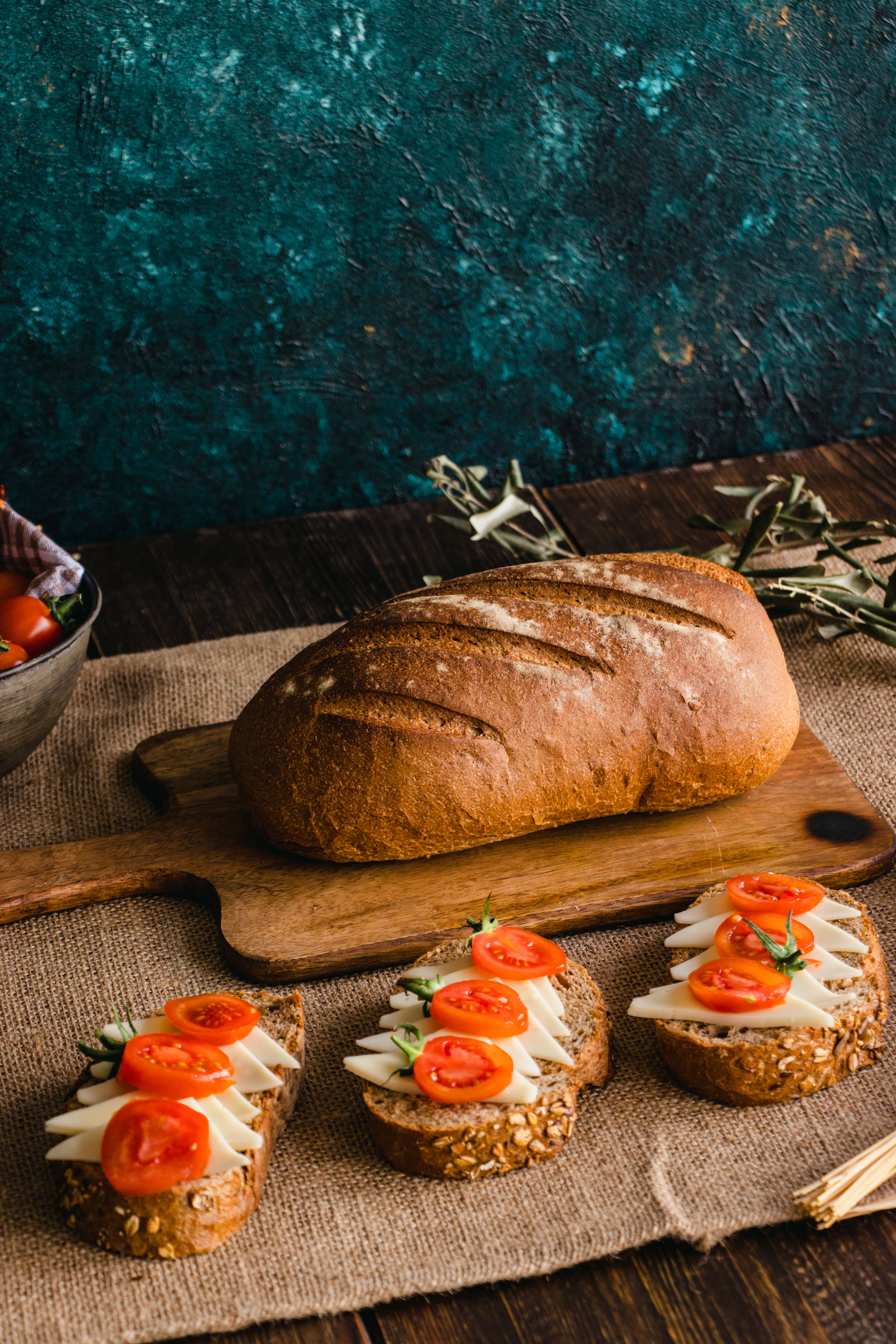 Rustic Bread with Cheese and Tomatoes on Display · Free Stock Photo