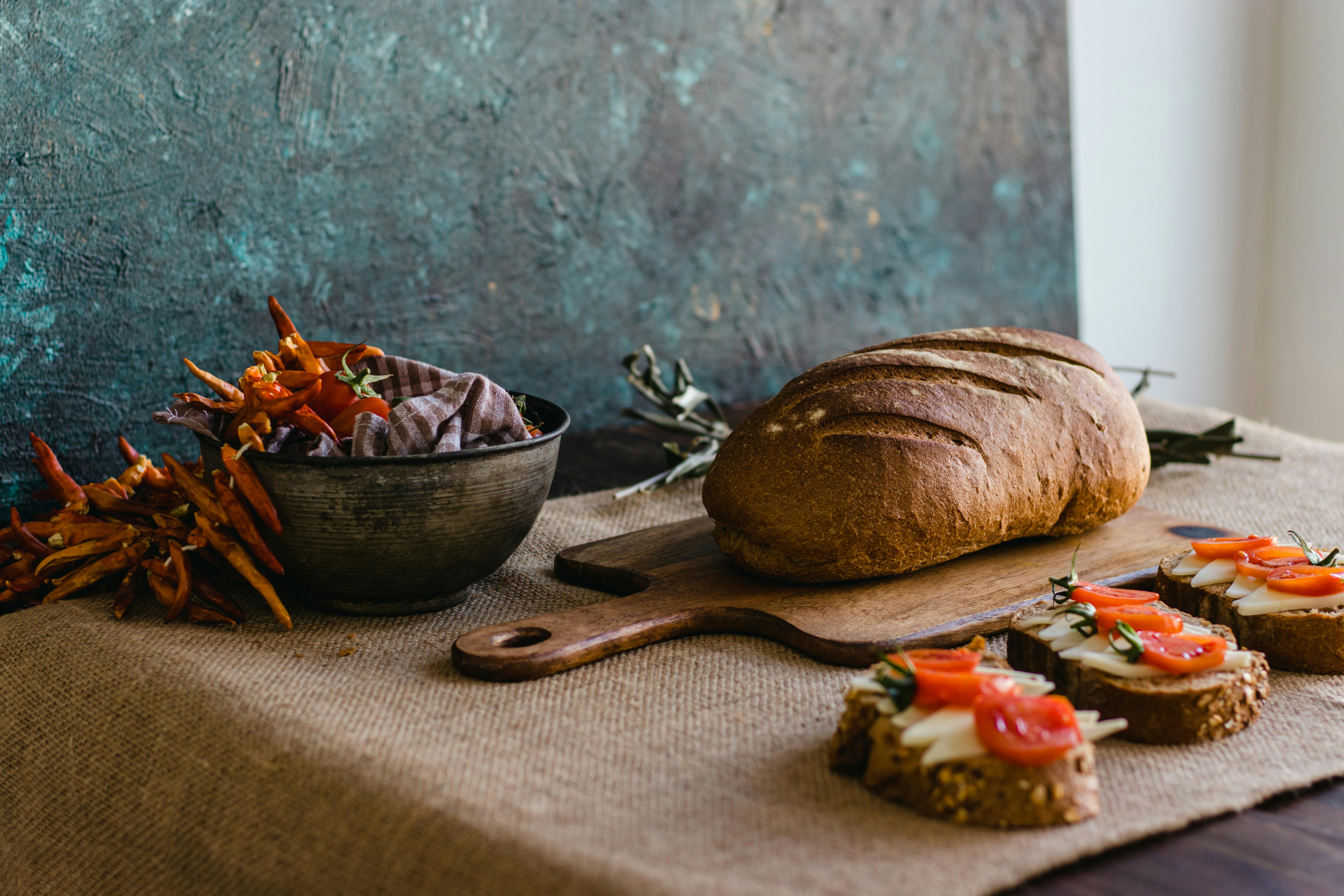 Rustic Bread and Vegetables on a Wooden Table · Free Stock Photo