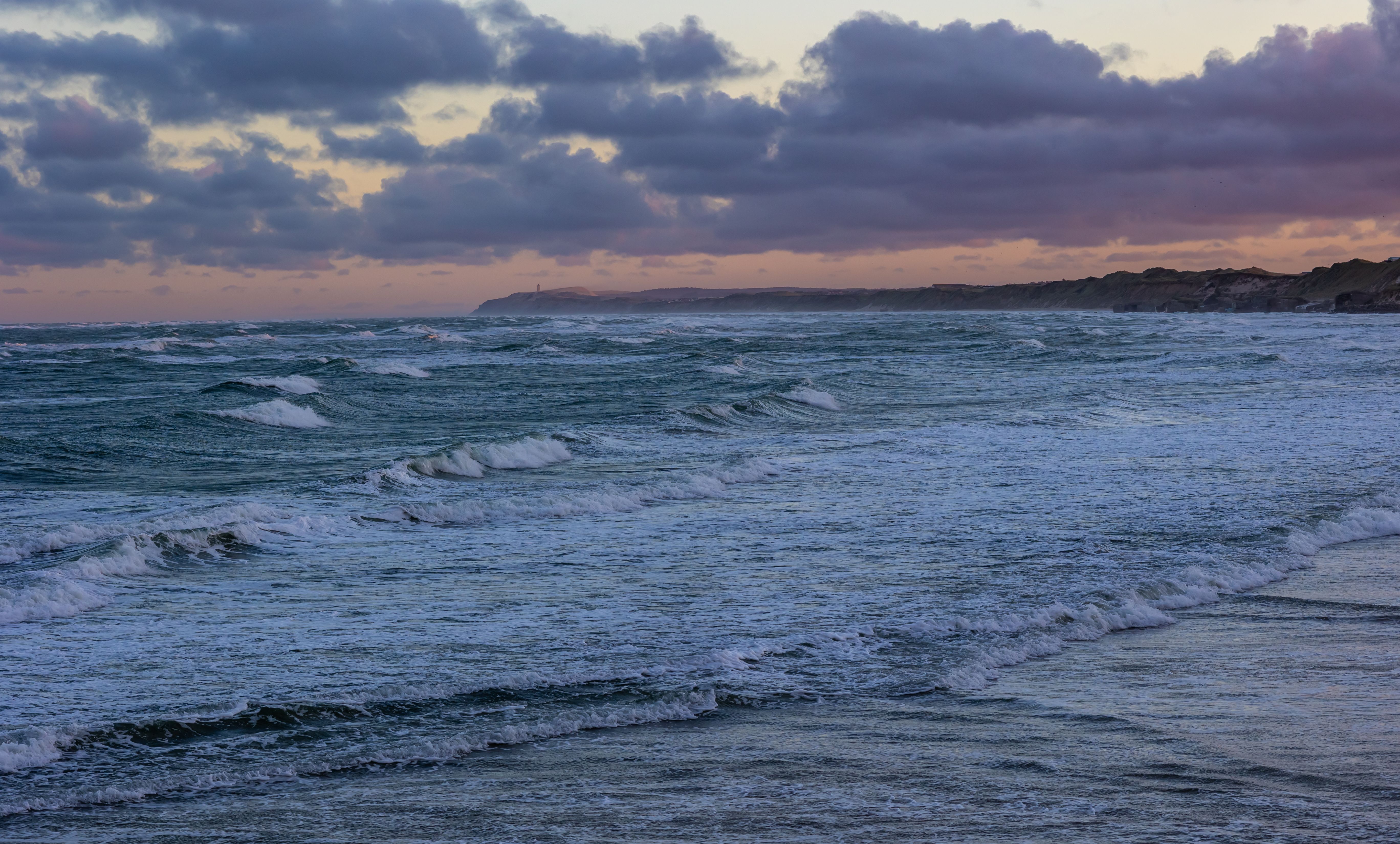 Dramatic Ocean Waves Under Moody Sunset Sky · Free Stock Photo