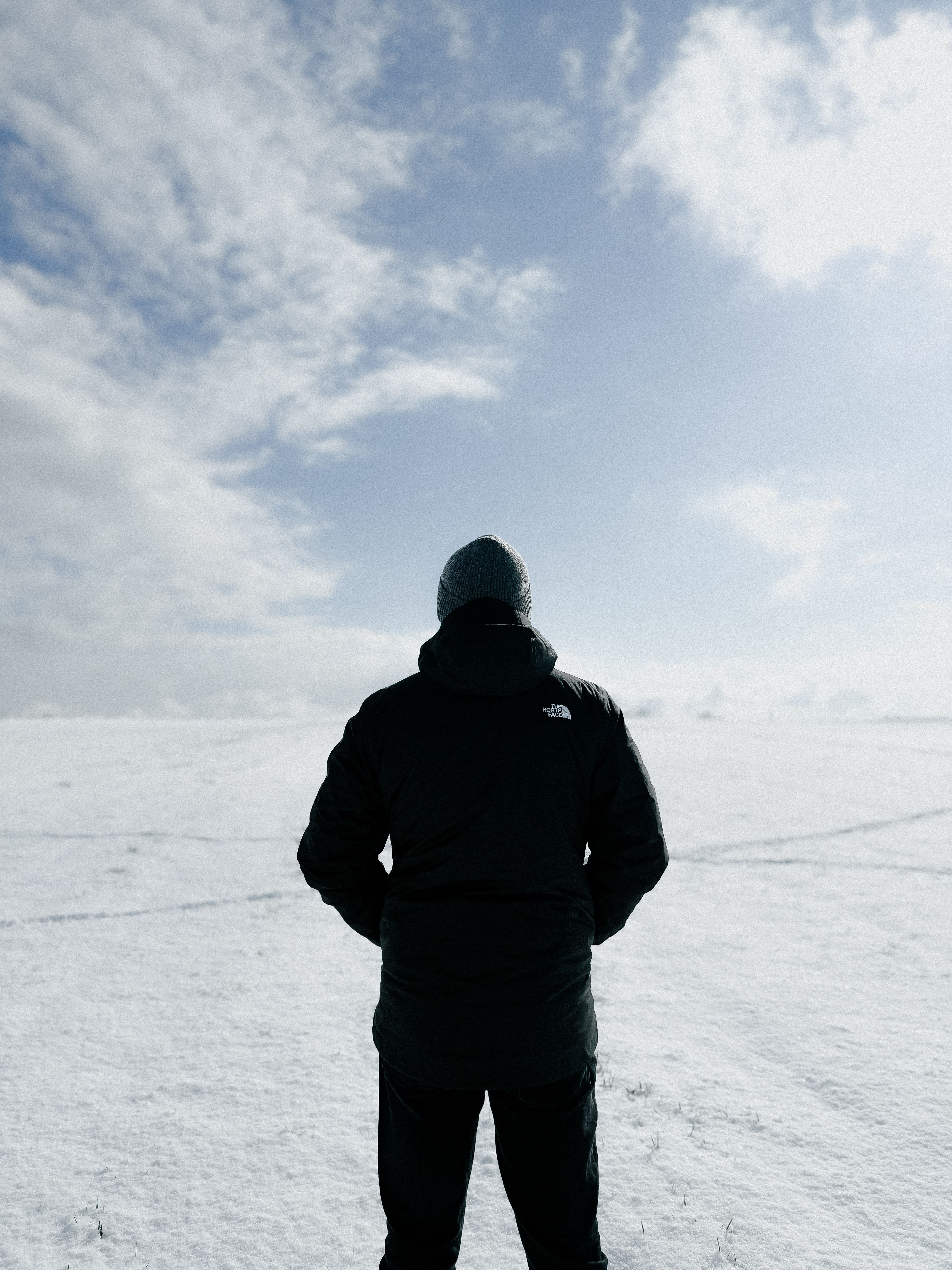 Person in Winter Jacket Standing in Snowy Landscape · Free Stock Photo
