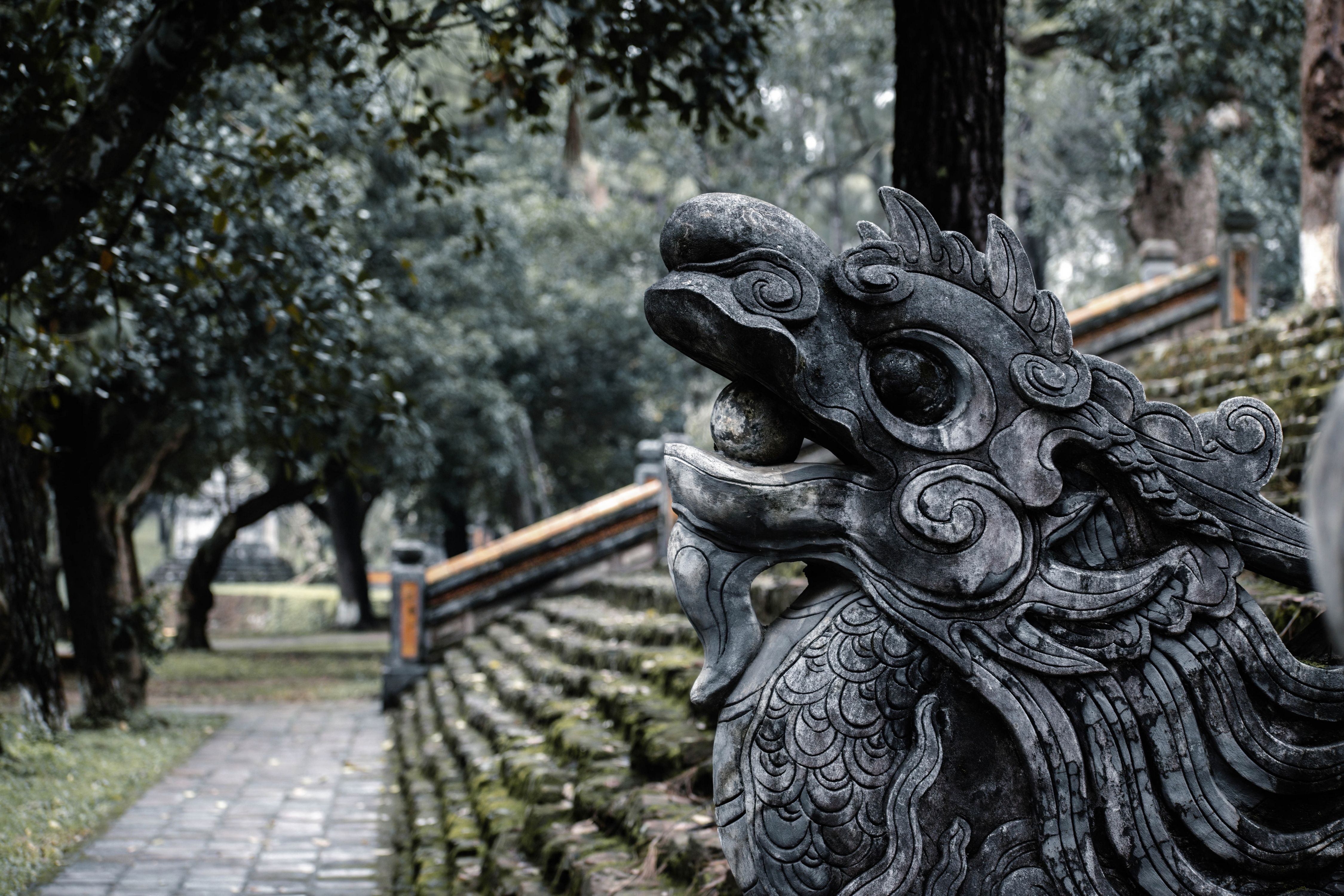 Ancient Stone Dragon Sculpture in Lush Park · Free Stock Photo