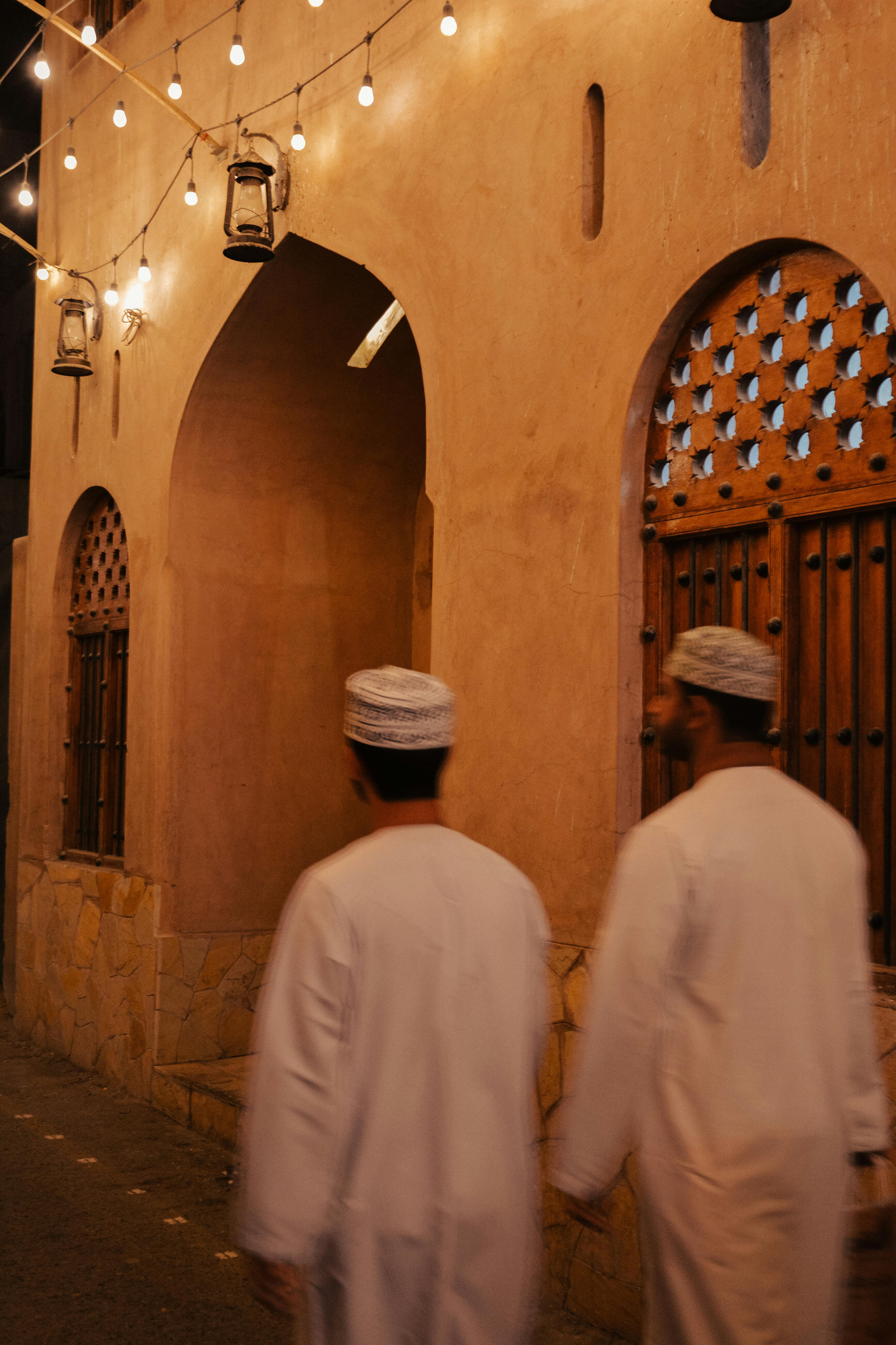 Group Walking on Corniche in Oman by the Sea · Free Stock Photo