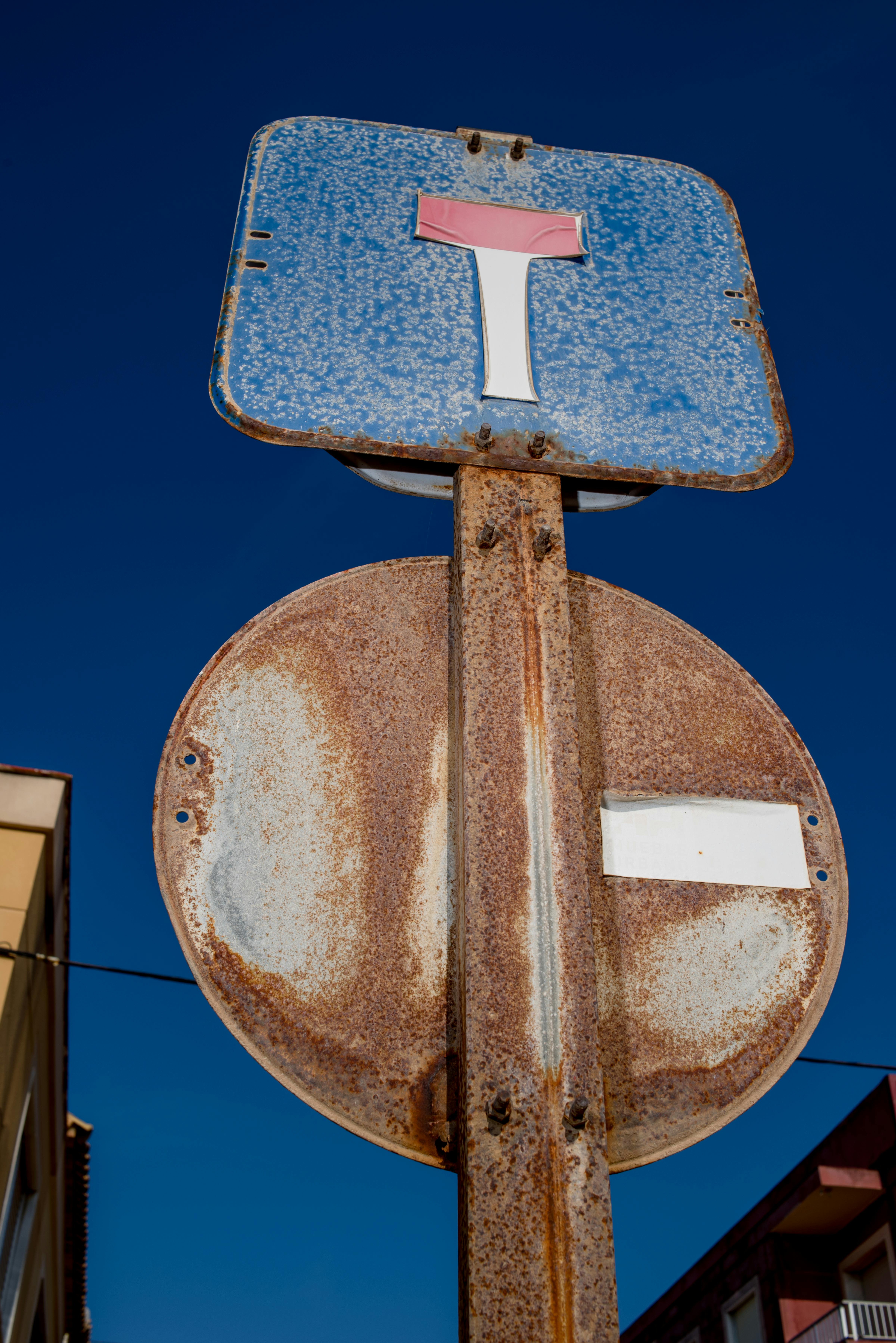 Rusty Road Signs Against Blue Sky · Free Stock Photo