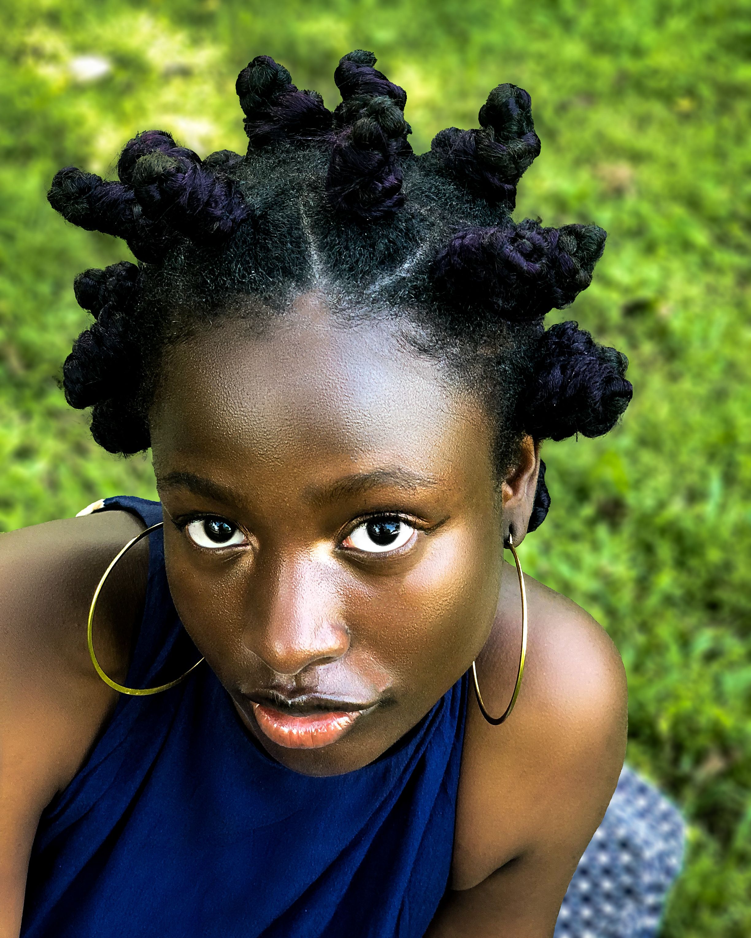 Portrait of a Young Woman with Bantu Knots Outdoors · Free Stock Photo