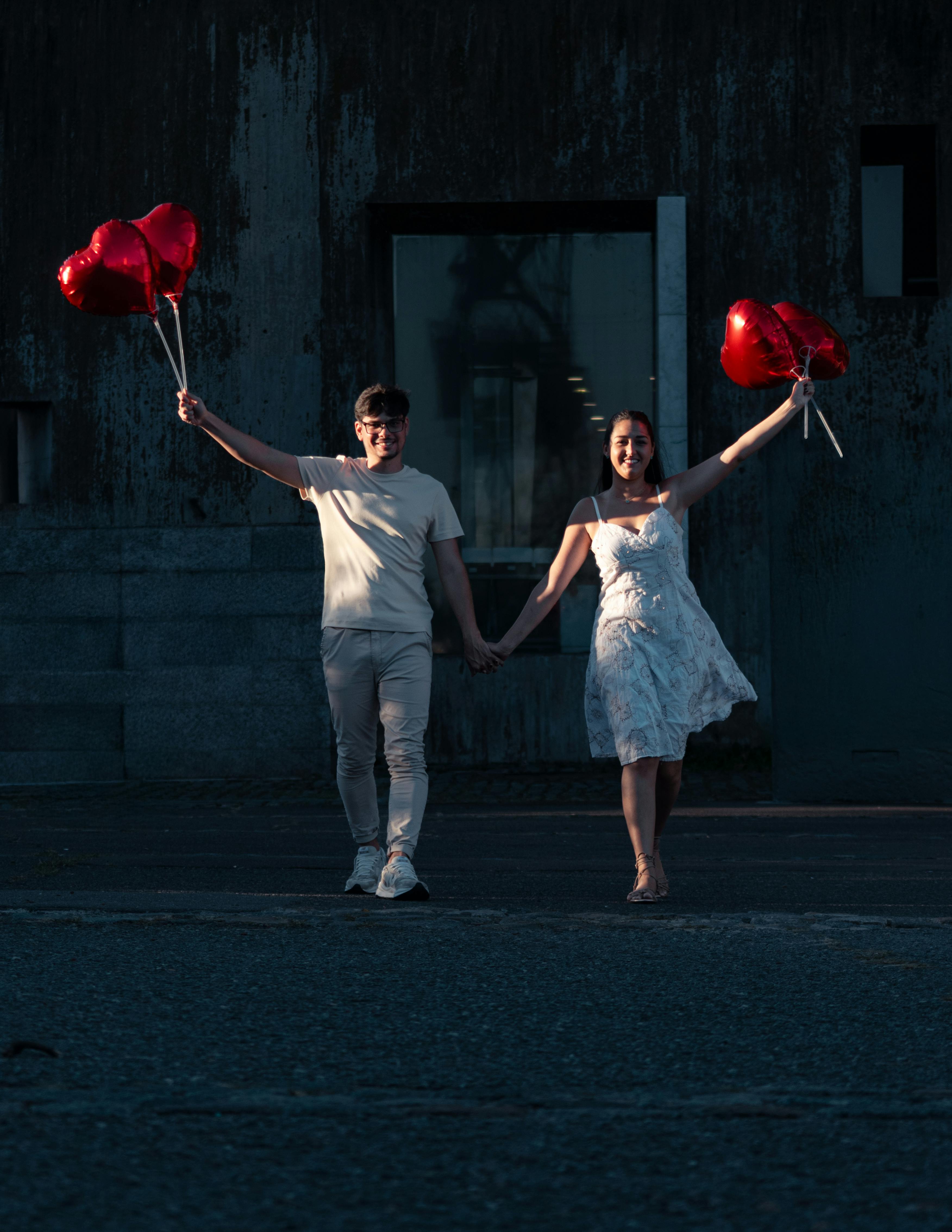 Romantic Couple Walking with Heart Balloons in Buenos Aires · Free Stock Photo
